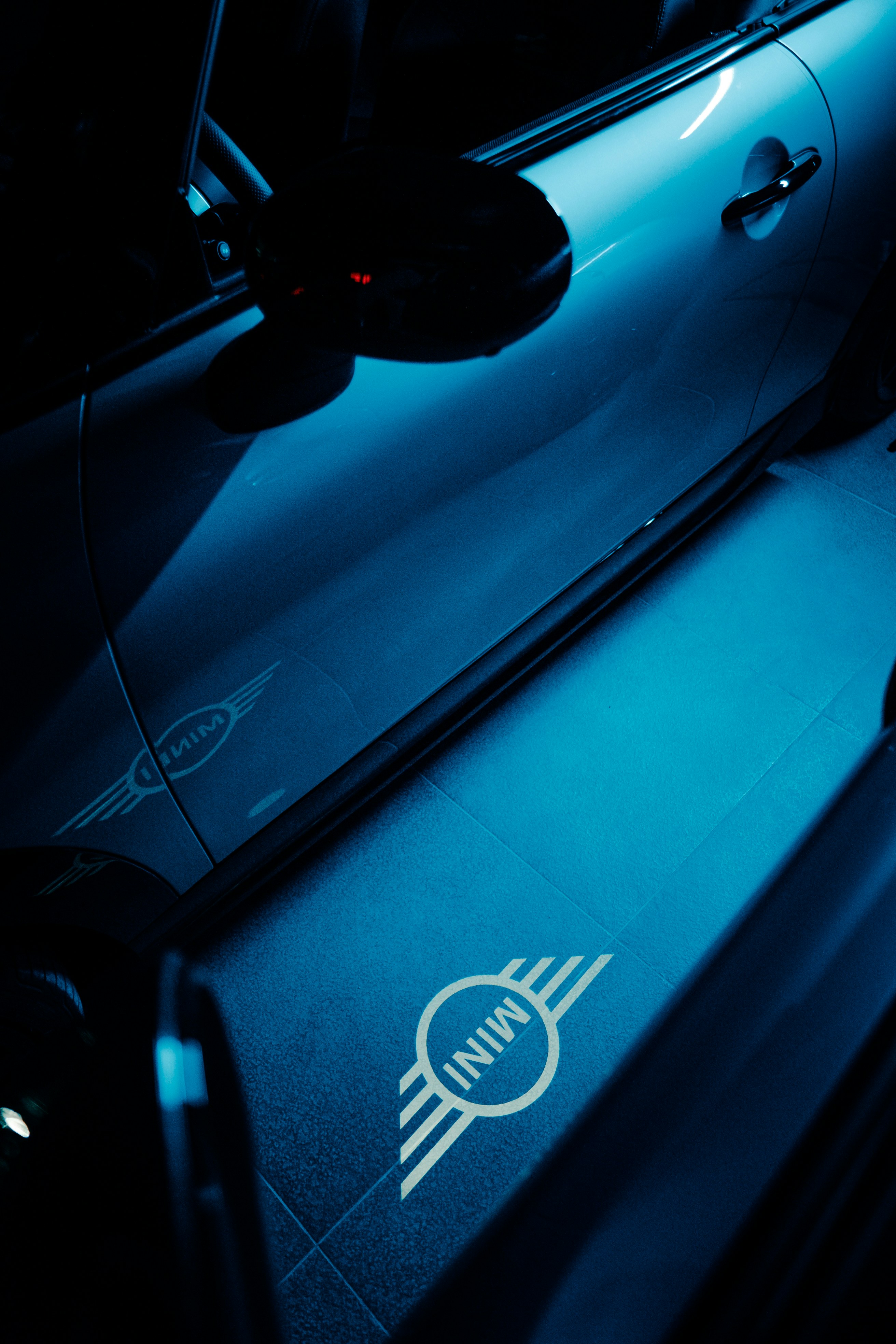 Blue Neon Car Wing: A Minimalist Reflection in Steel and Light