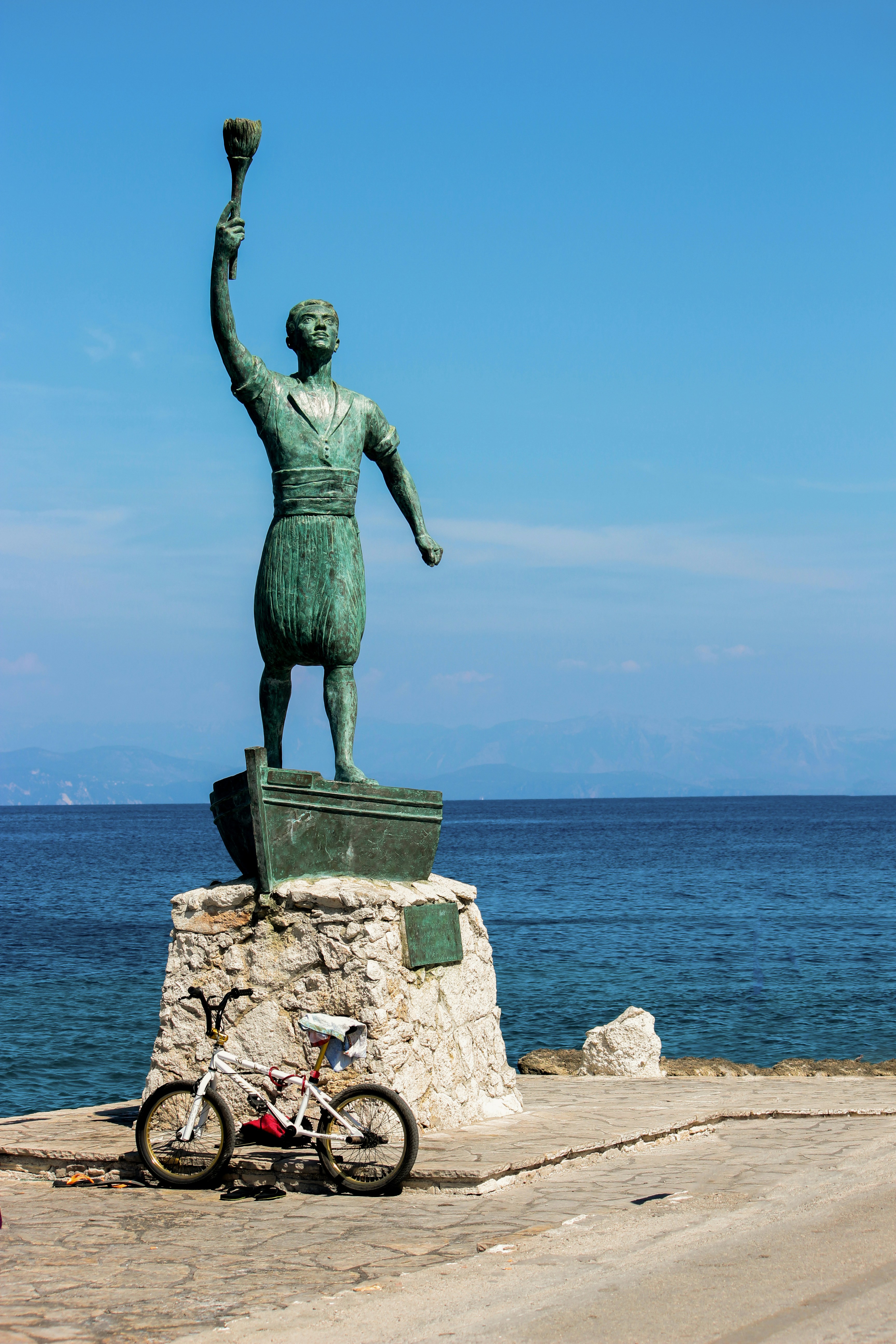 Bronze Torchbearer by the Sea: A Solitary Sentinel on the Promenade