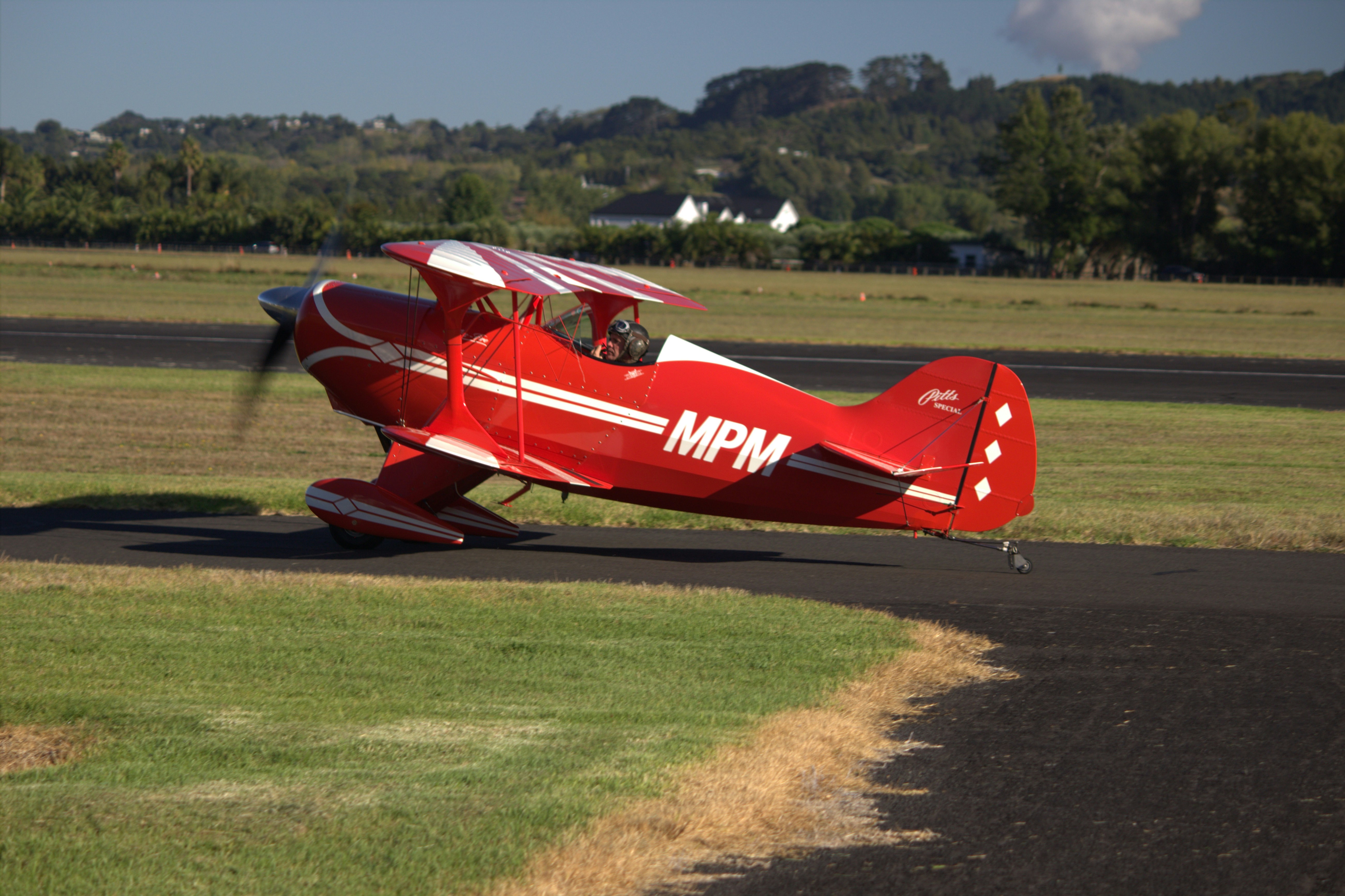 A red biplane is on the runway. photo – Free New zealand Image on Unsplash