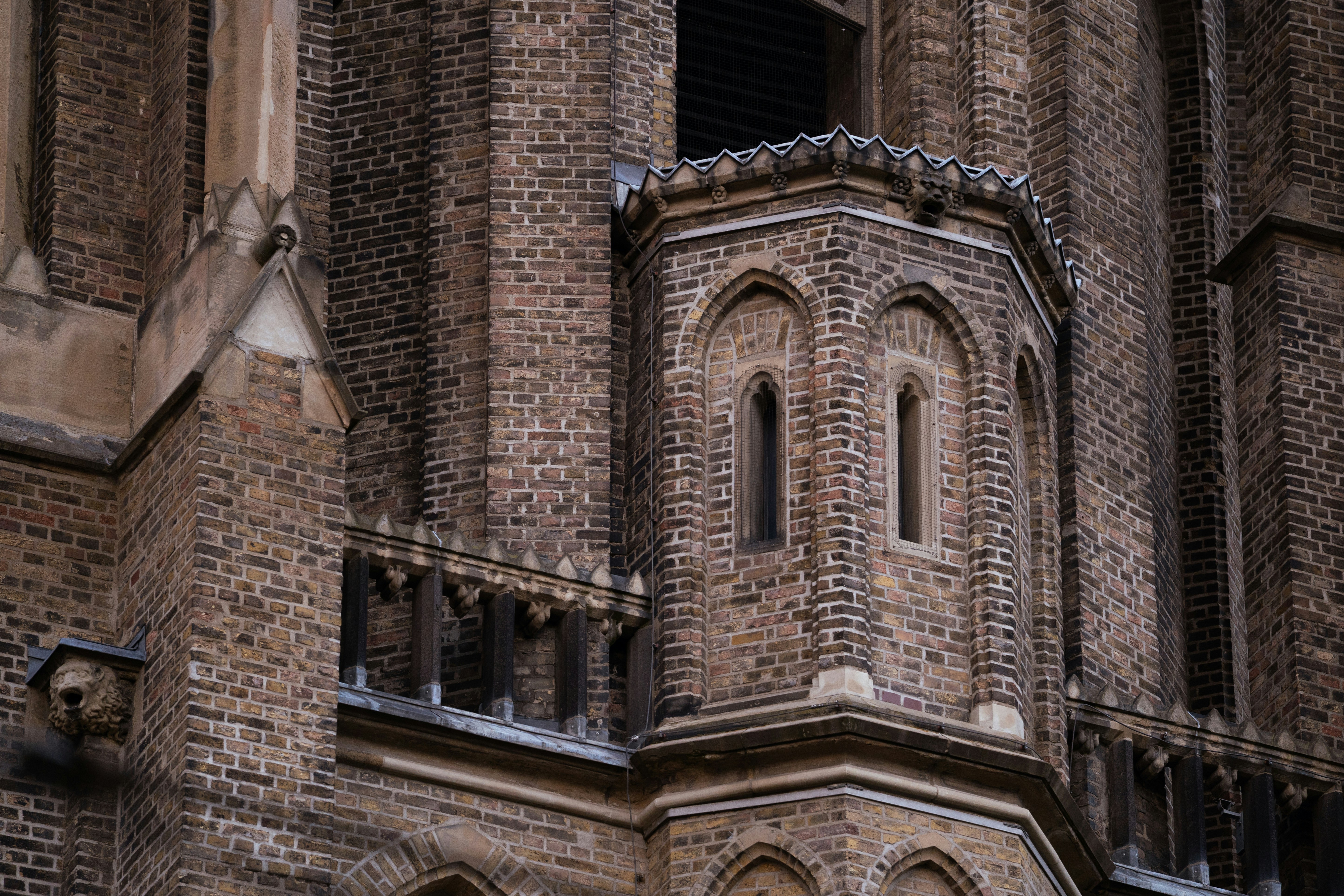 Brick architecture with arched windows and gargoyle. photo – Free ...