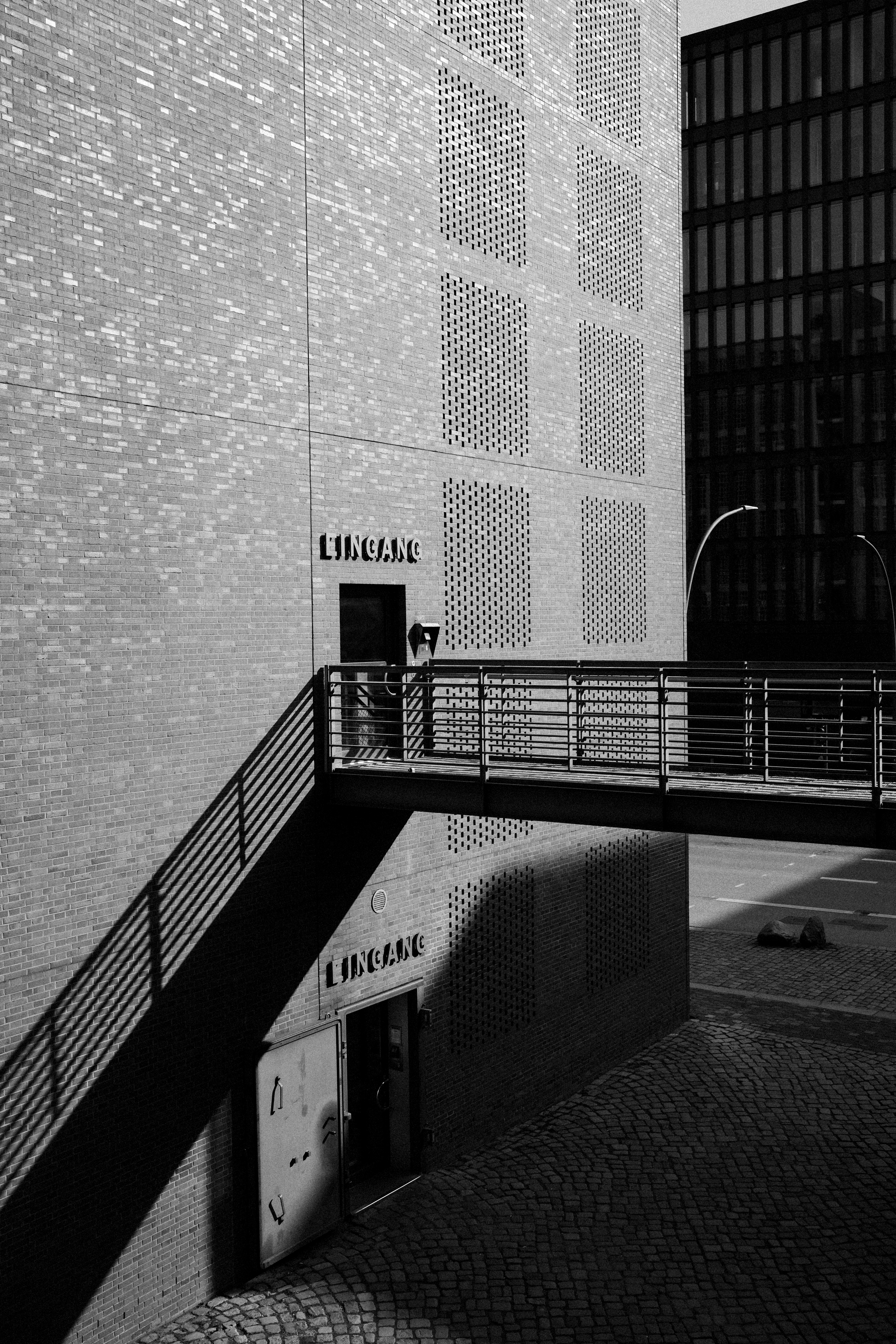 Monochrome Crossing: A Bridge Between Brick Facades