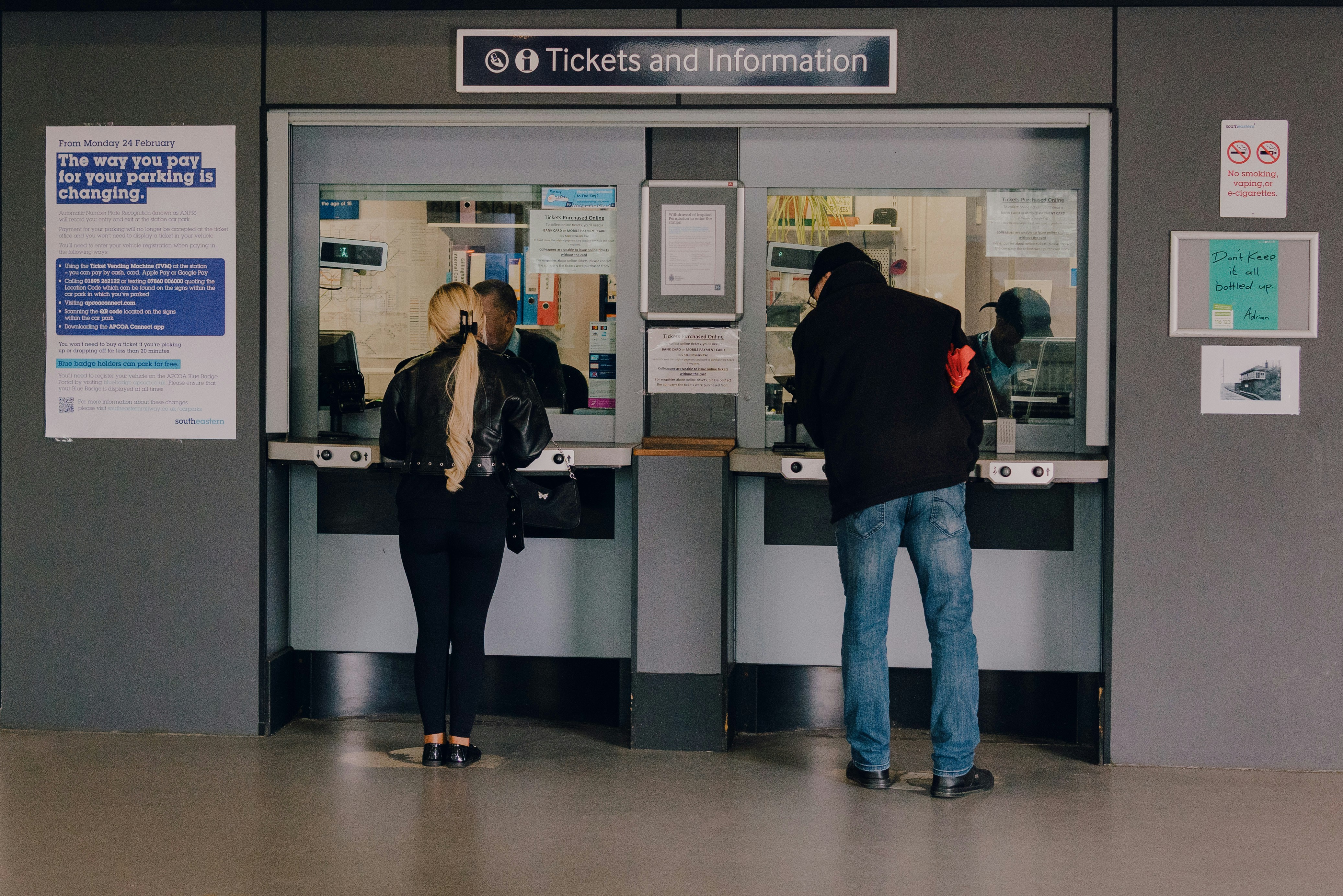 People are buying tickets at a ticket booth. photo – Free Woman Image ...