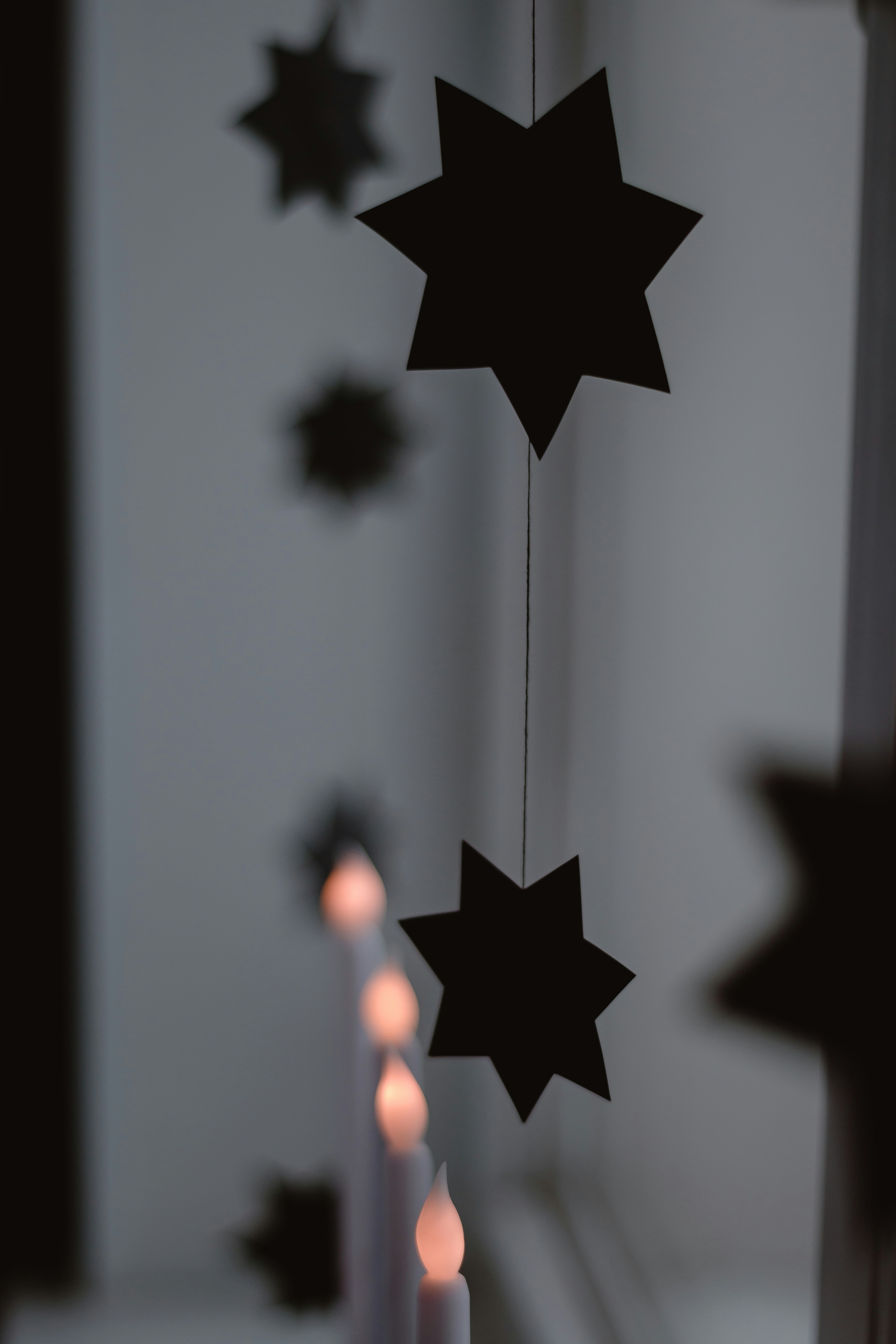 Hanging Black Star Ornaments in a Quiet Studio