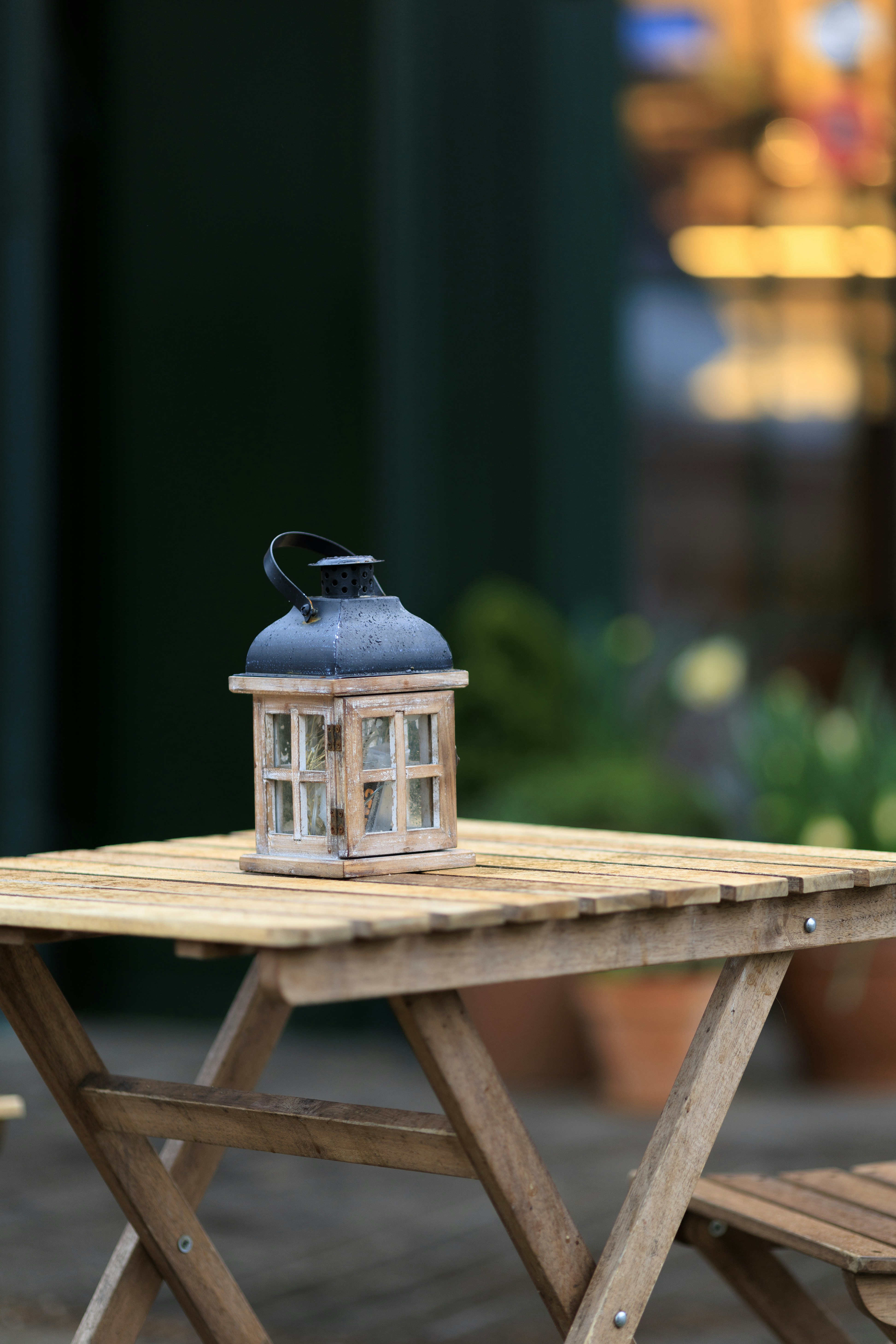 Rustic Lantern on a Sunlit Table: A Quiet Outdoor Still Life
