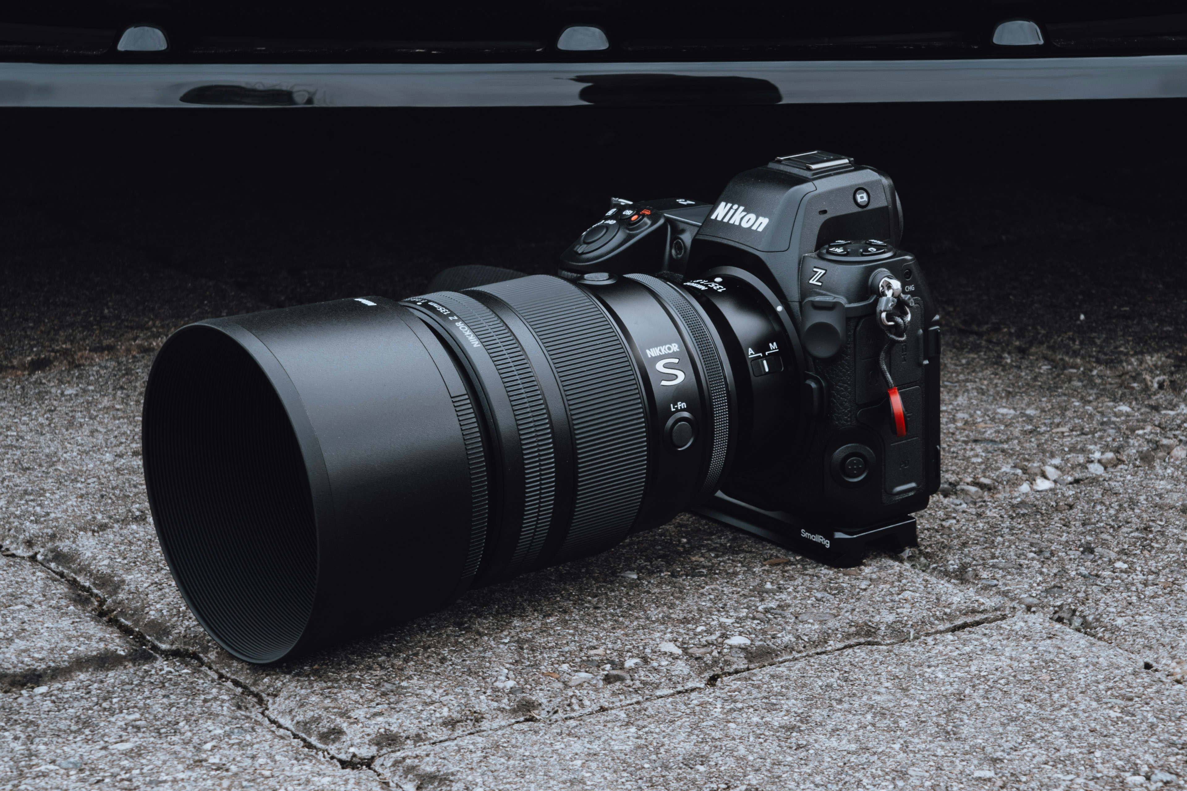 Nikon on the Cracked Pavement: A Street-Ready Telephoto Rig Waiting for a Moment