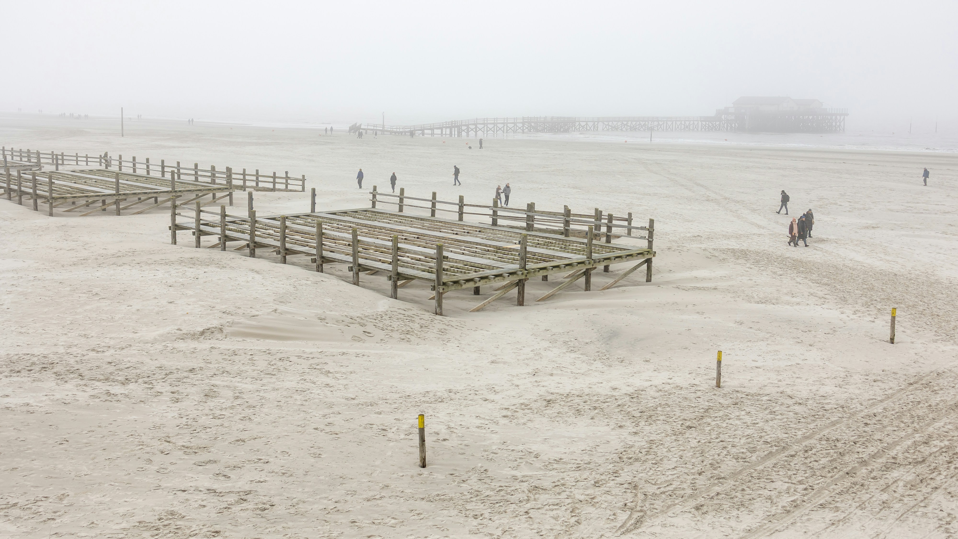 Fog-swept Beachwalk: Weathered Planks Reaching into the Mist