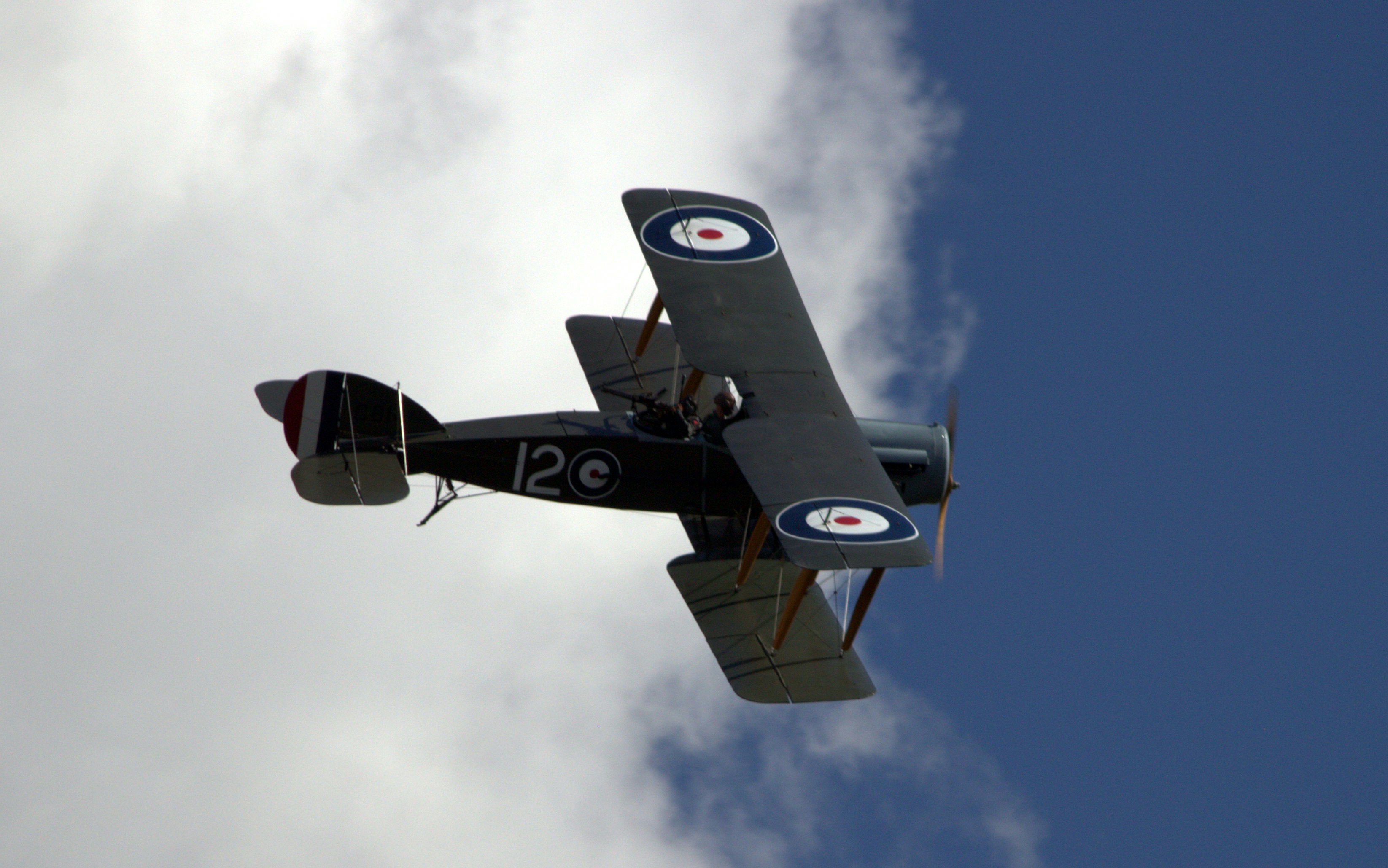 Dusty Sky Acrobat: A Vintage Biplane Streaks Through