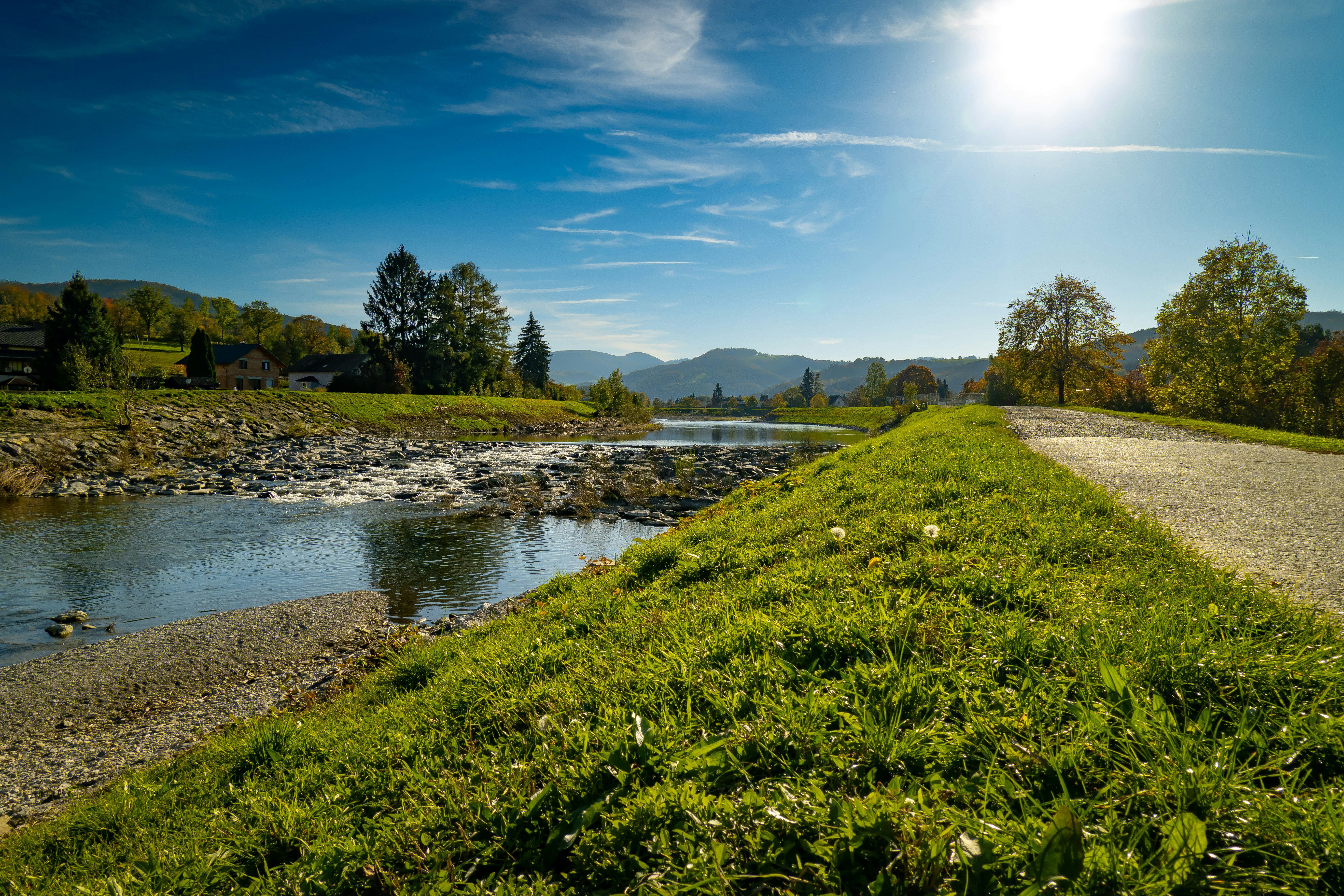 Sunlit Pathway Along the Austrian Riverbend