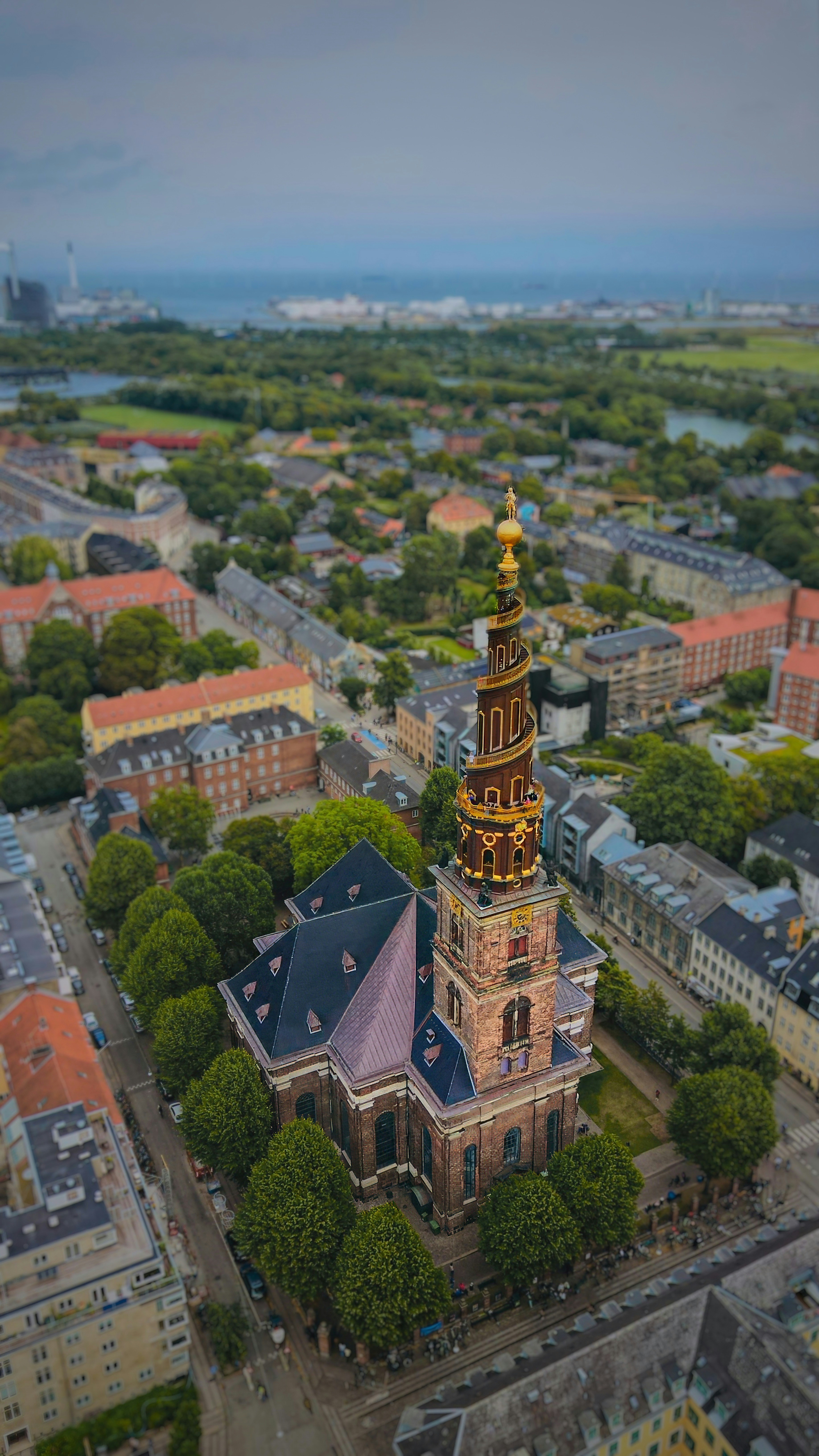 An aerial view of a church with a tall spire. photo – Free Drone Image ...