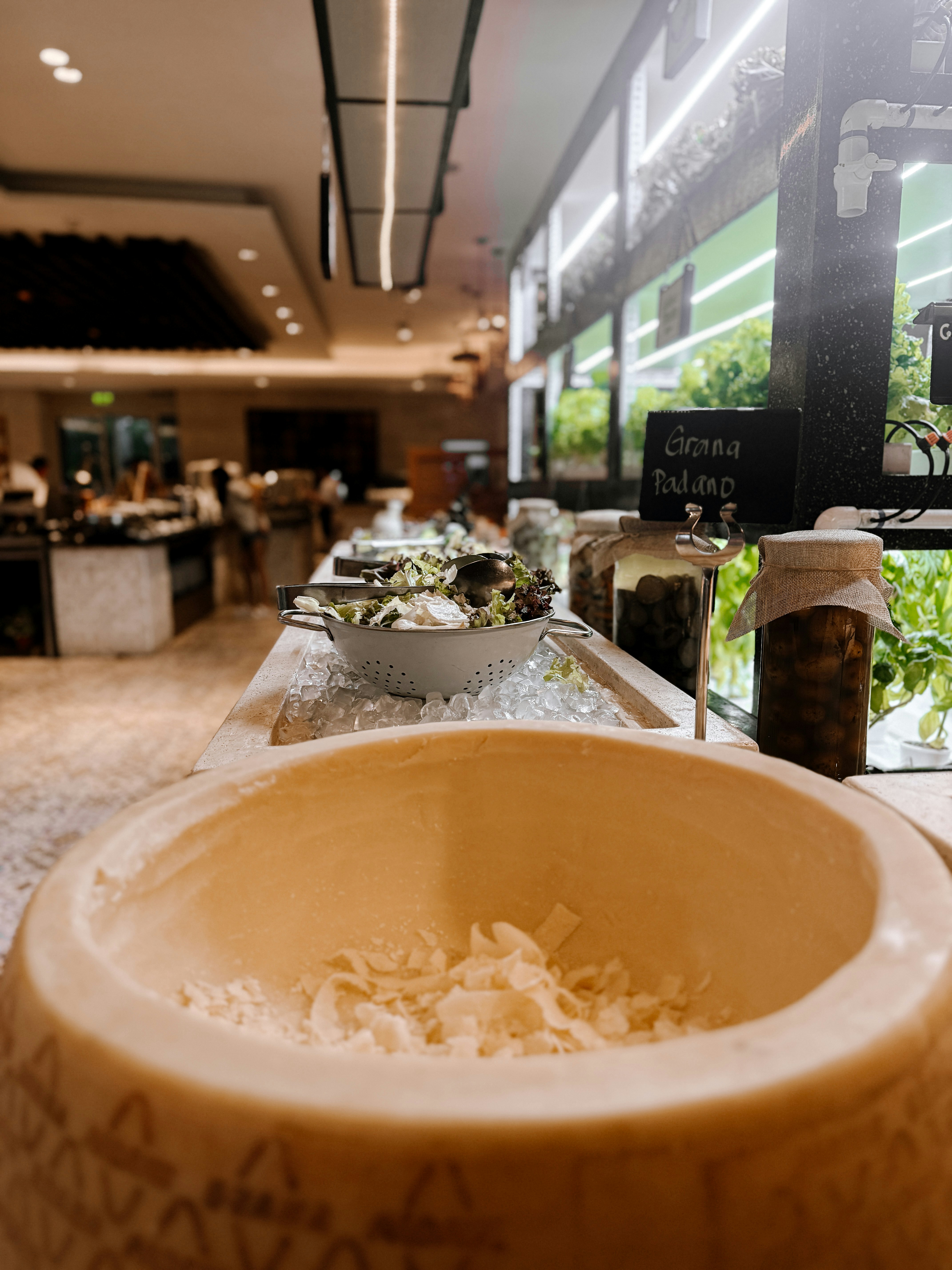Cheese Wheel Anchoring a Lively Buffet Scene