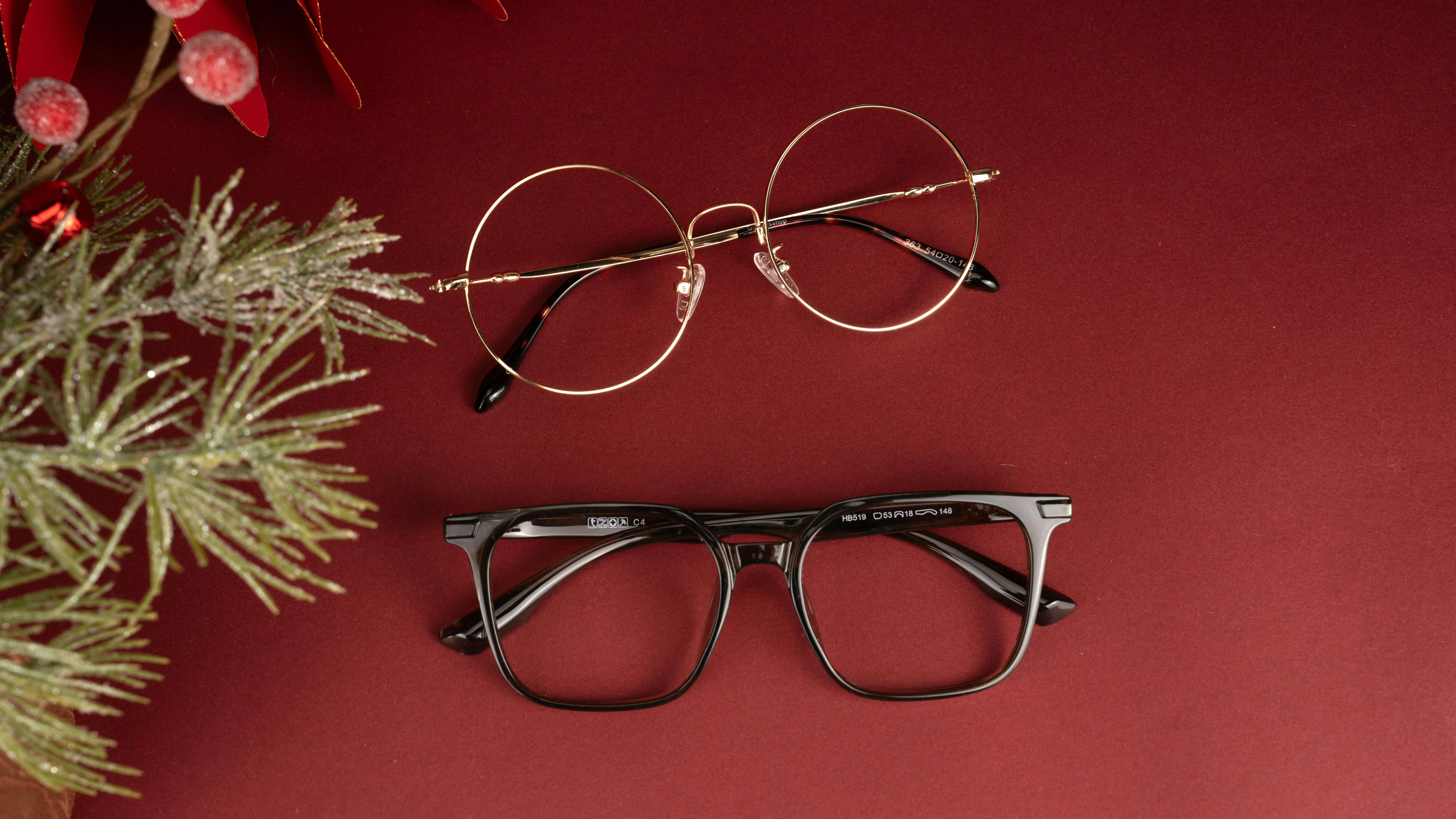 Two pairs of glasses rest on a red surface. photo – Free Glasses Image ...
