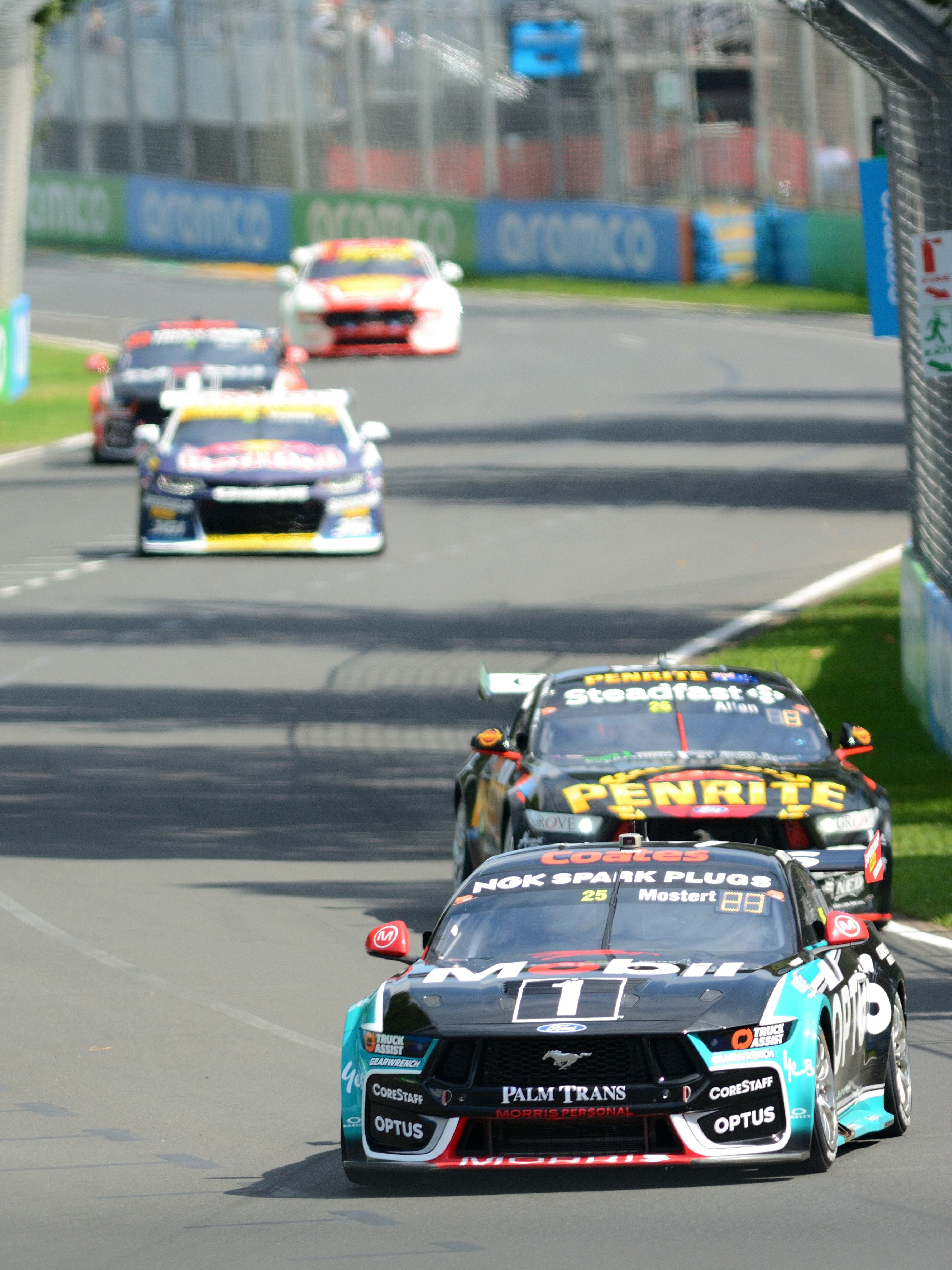 Race cars compete on a curved race track. photo – Free Car Image on ...