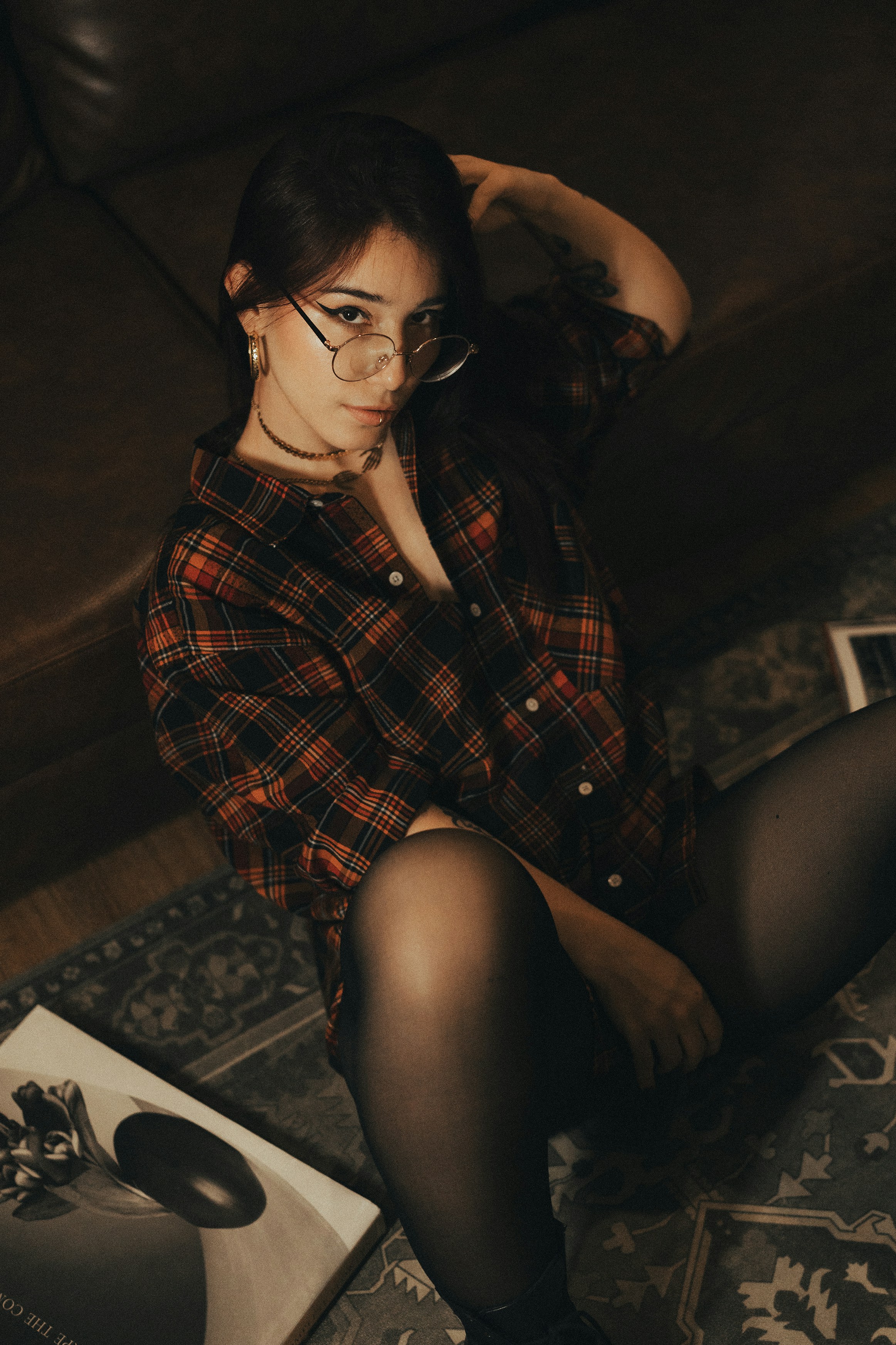 Woman in plaid shirt poses for a photo.