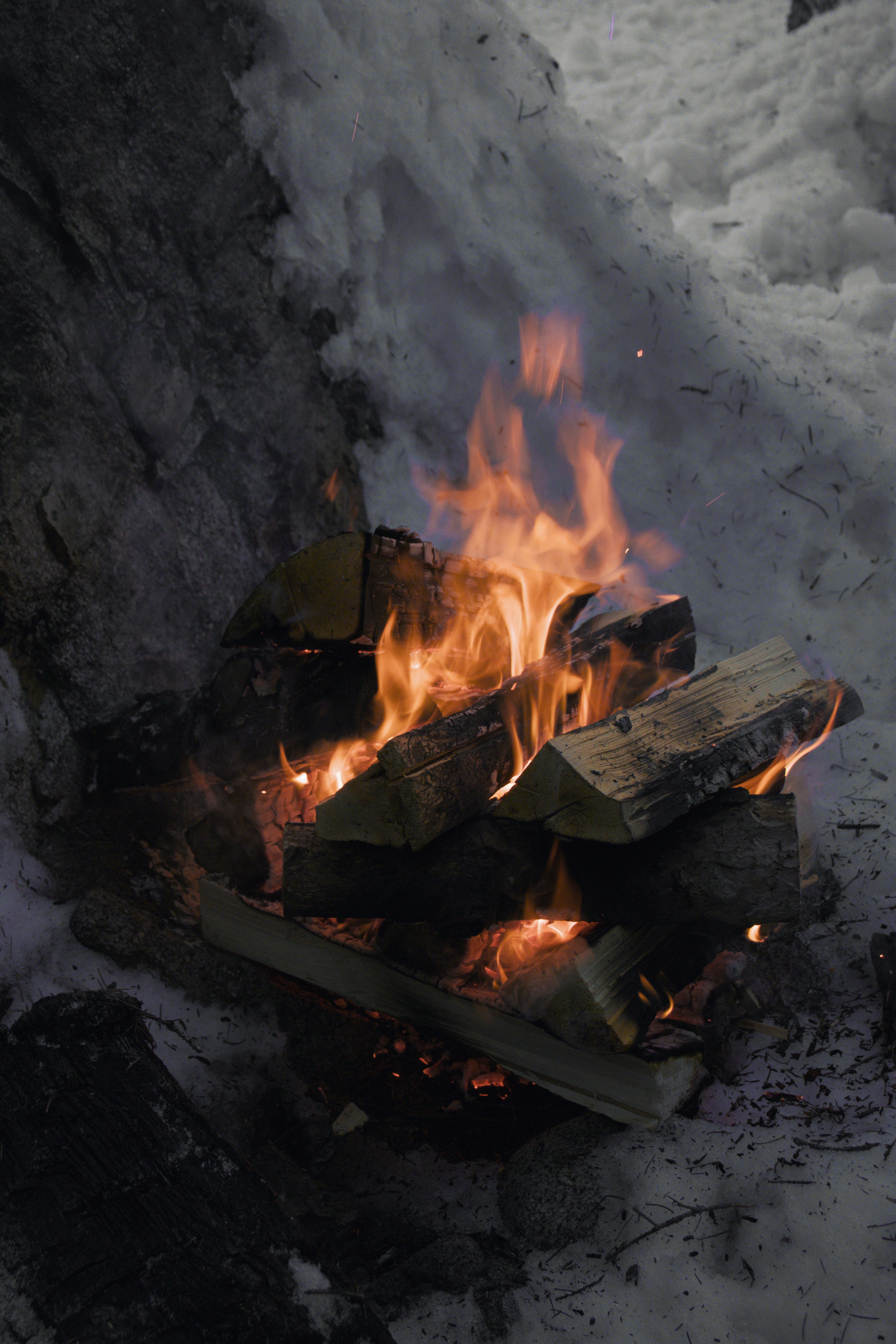 A crackling fire burns brightly in the snow. photo – Free Wallpaper ...