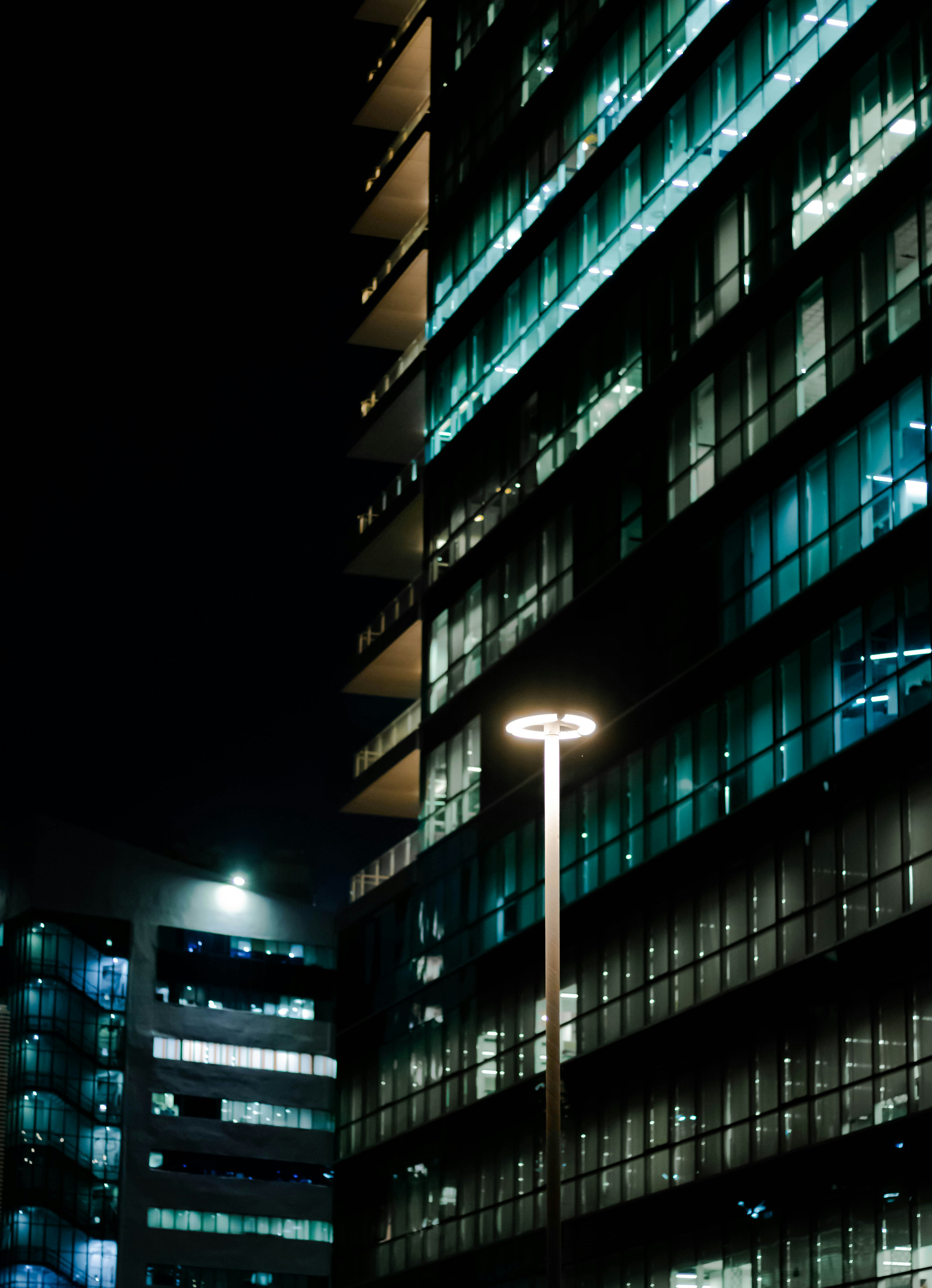 Lit windows of buildings at night. photo – Free Building Image on Unsplash
