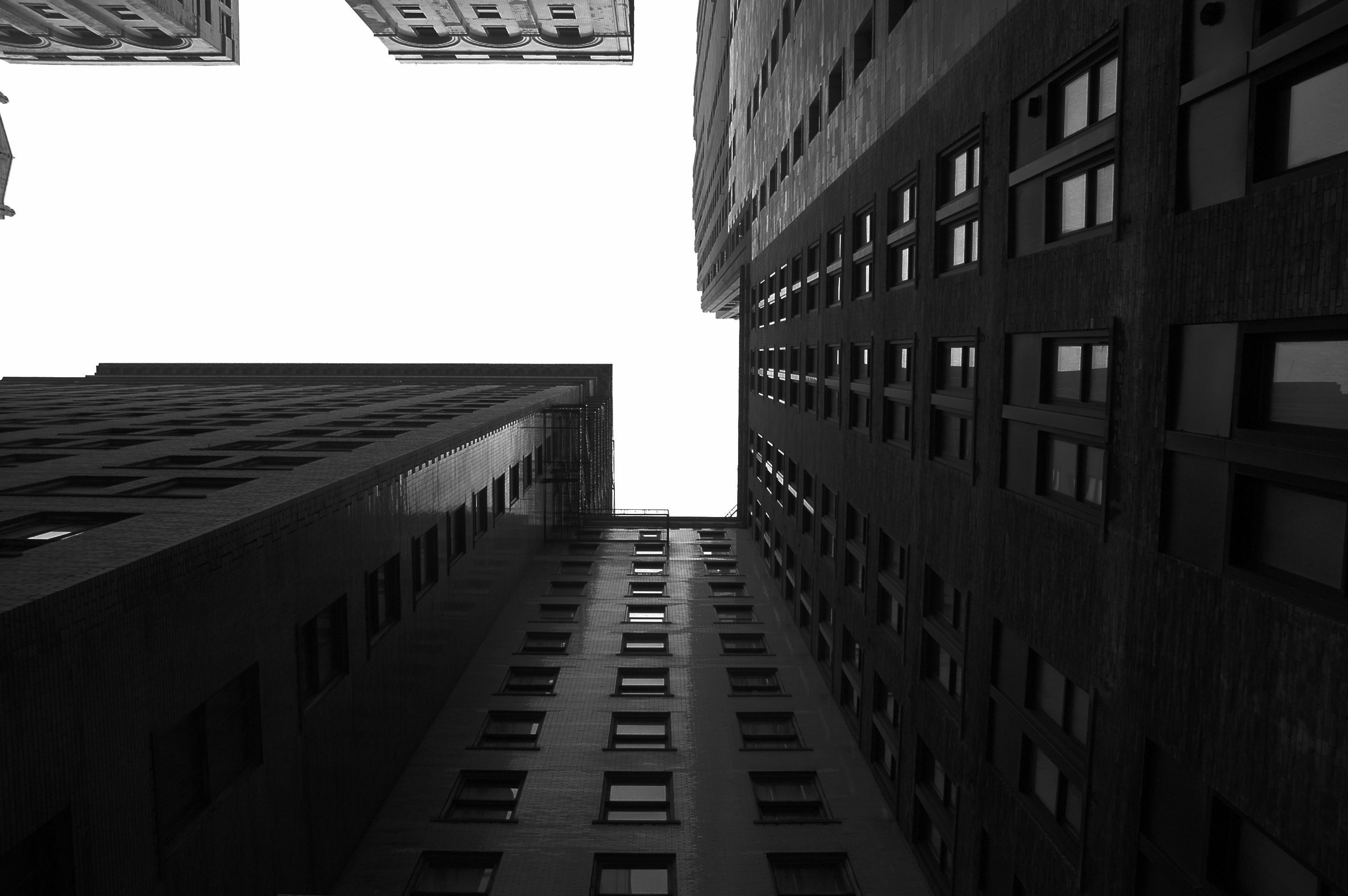 Tall buildings reaching up into the bright sky.