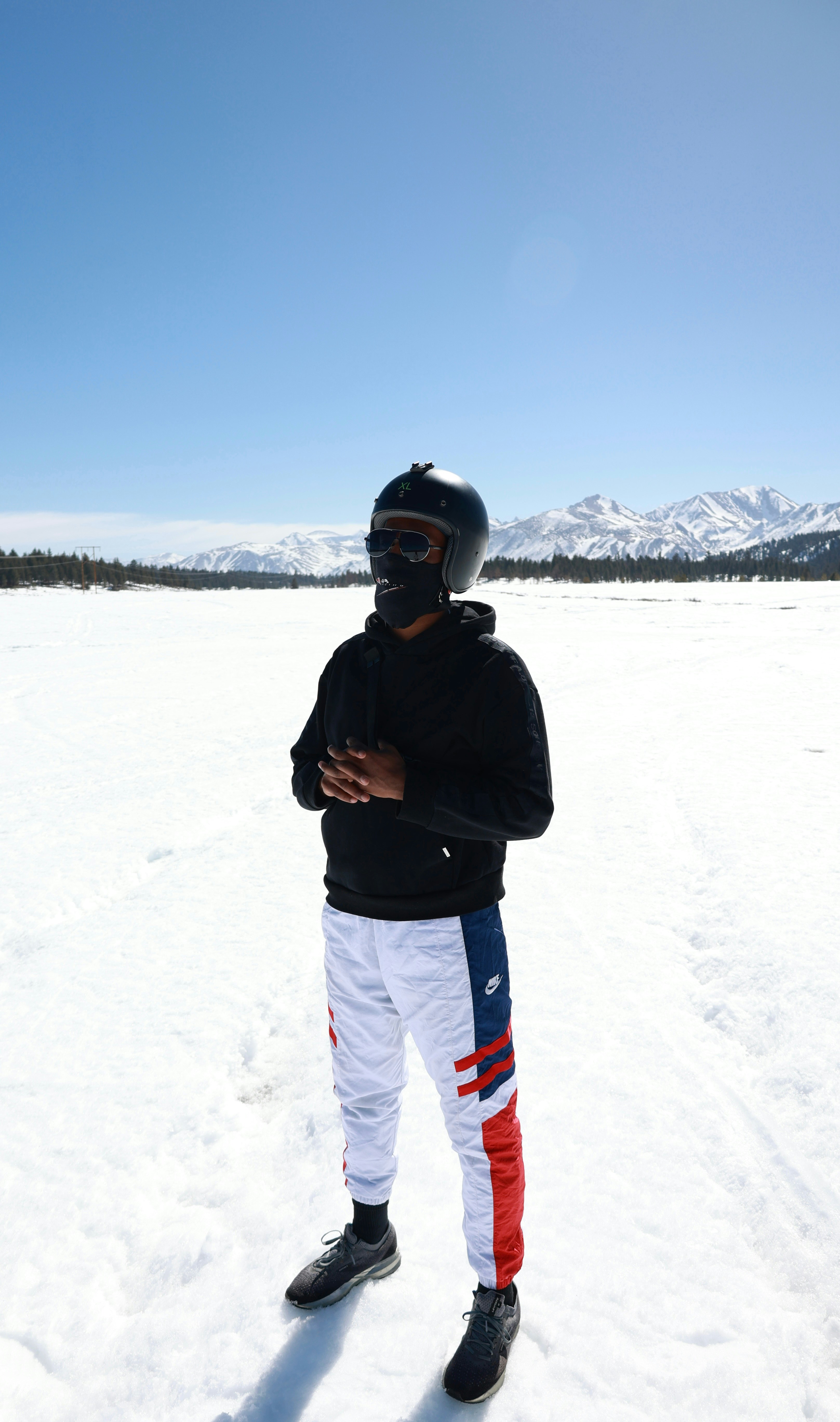 Snowfield Sentinel: A Helmeted Traveler Against the Alpine Horizon