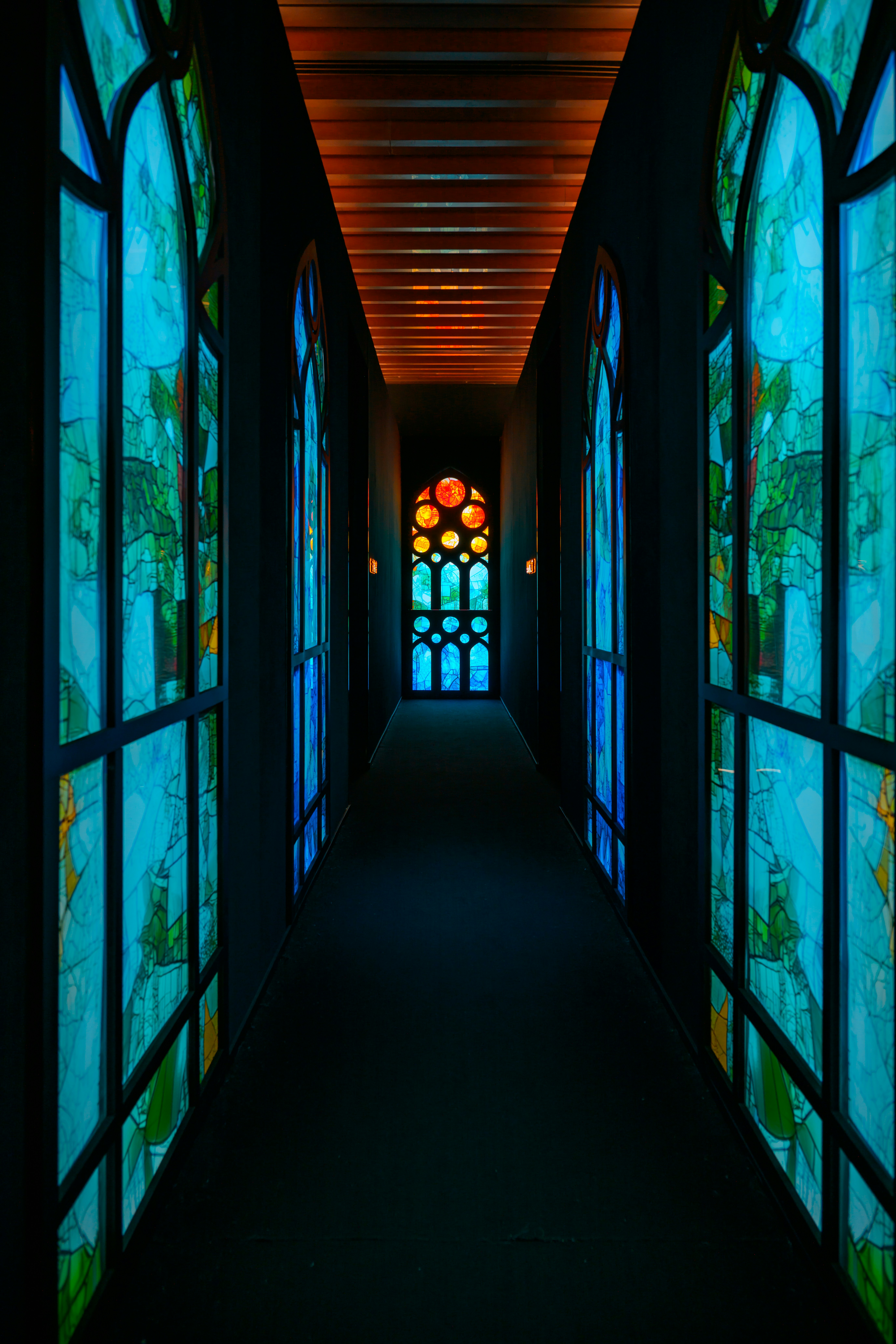 Hallway with colorful stained-glass windows and a door. photo – Free ...