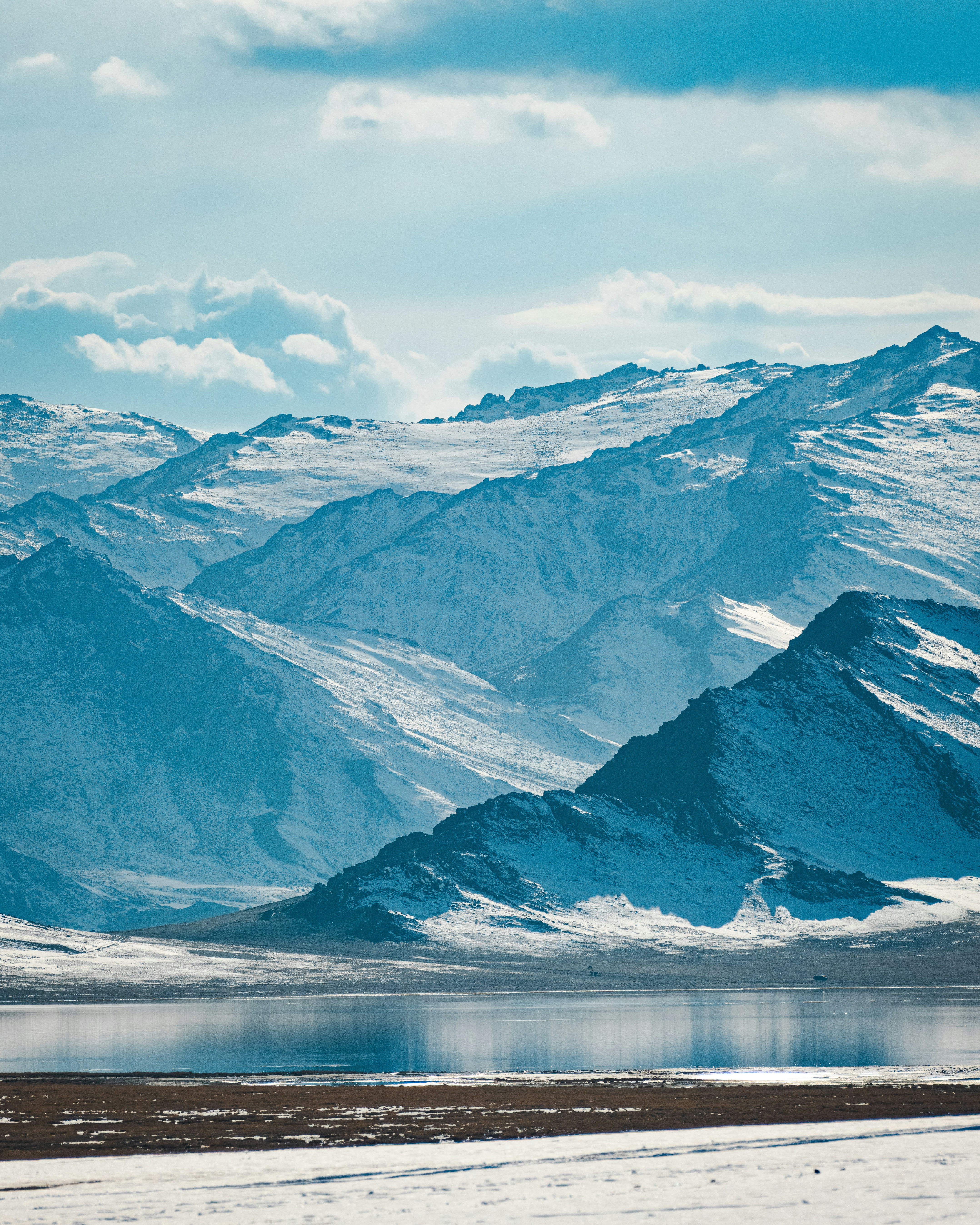Snowy mountains stand tall over a serene lake. photo – Free Mongolia ...