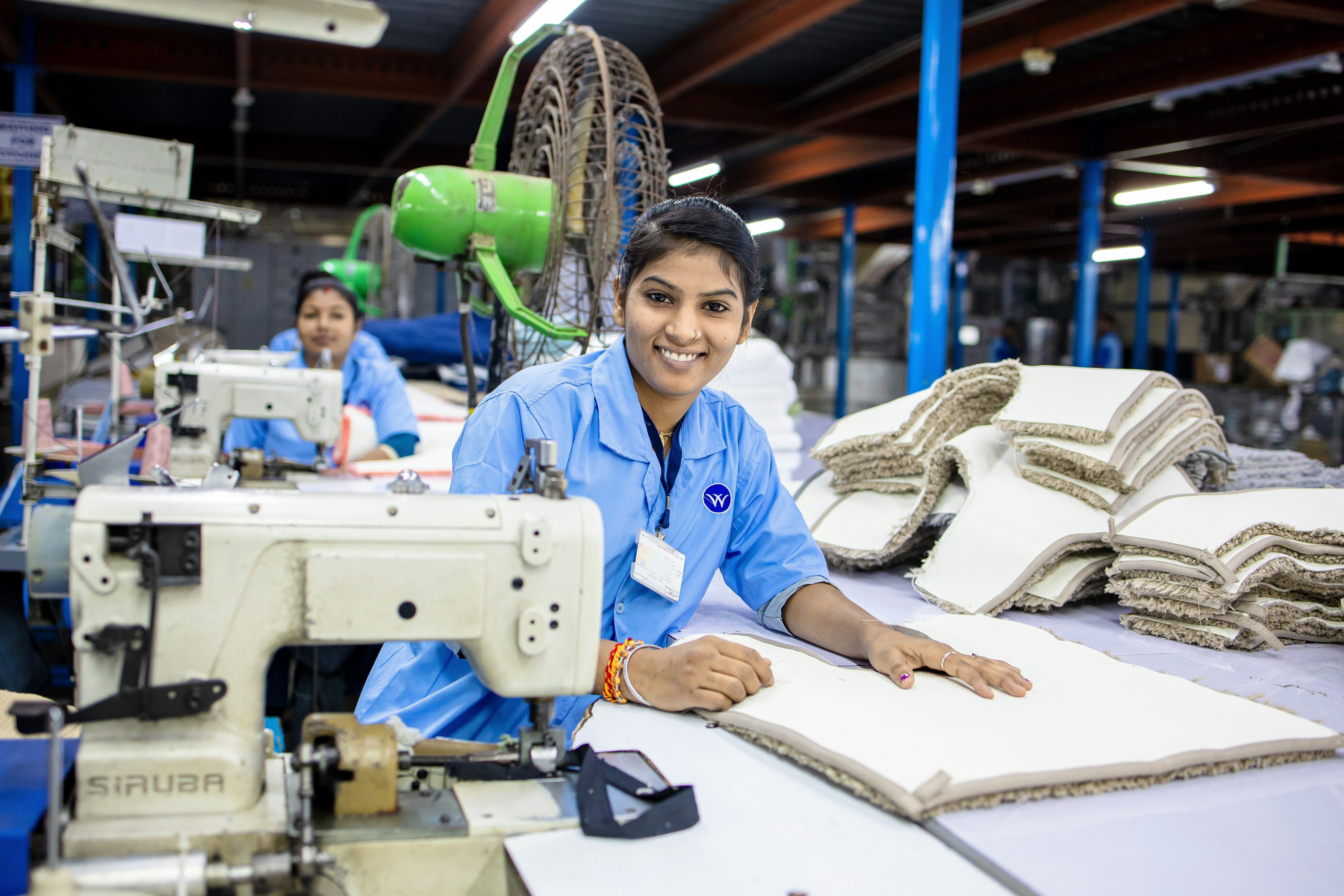 Factory workers sewing fabric together. photo – Free Woman Image on ...
