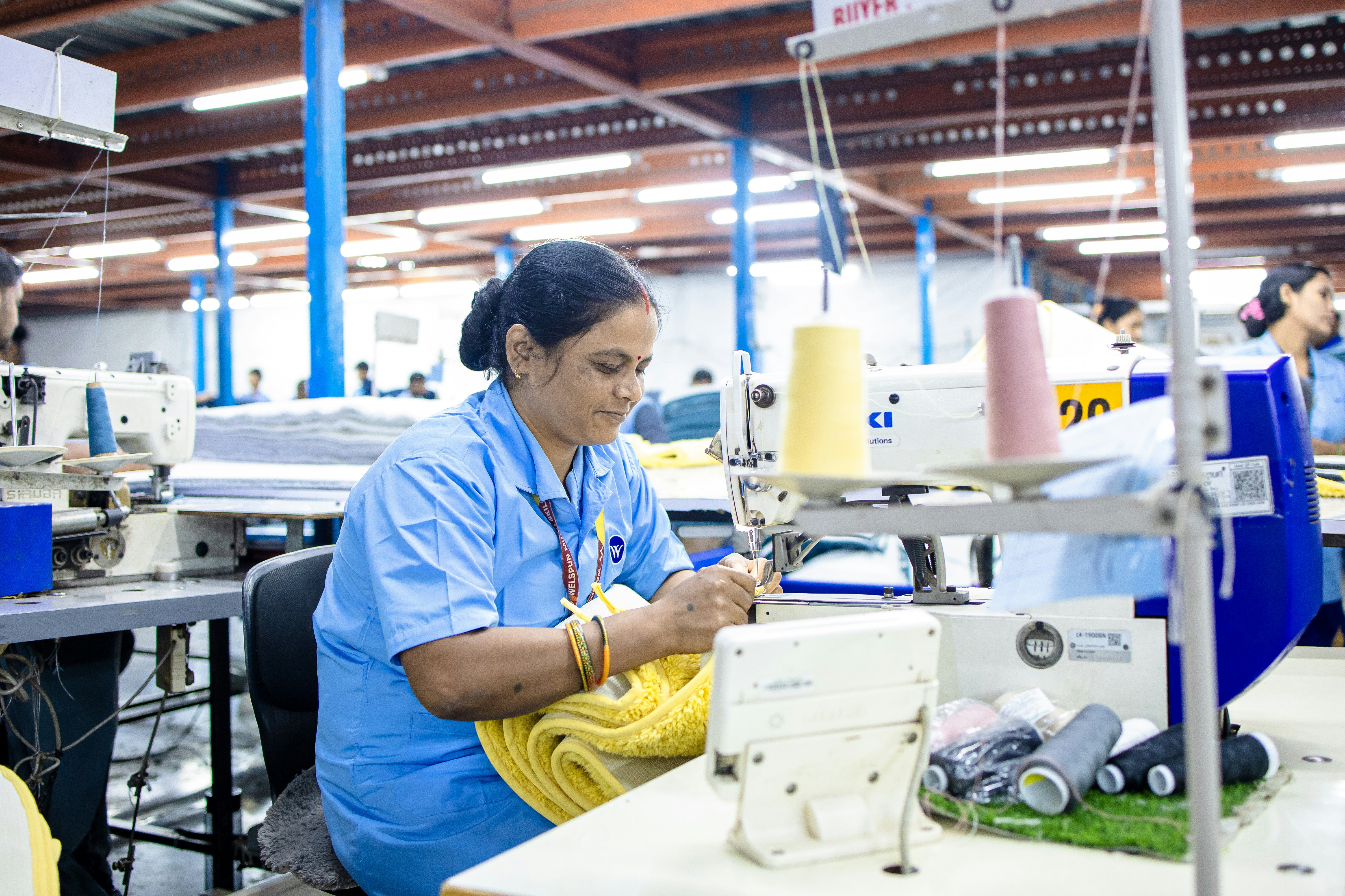 Blue-Cooled Threads: A Seamstress at Work in a Textile Factory