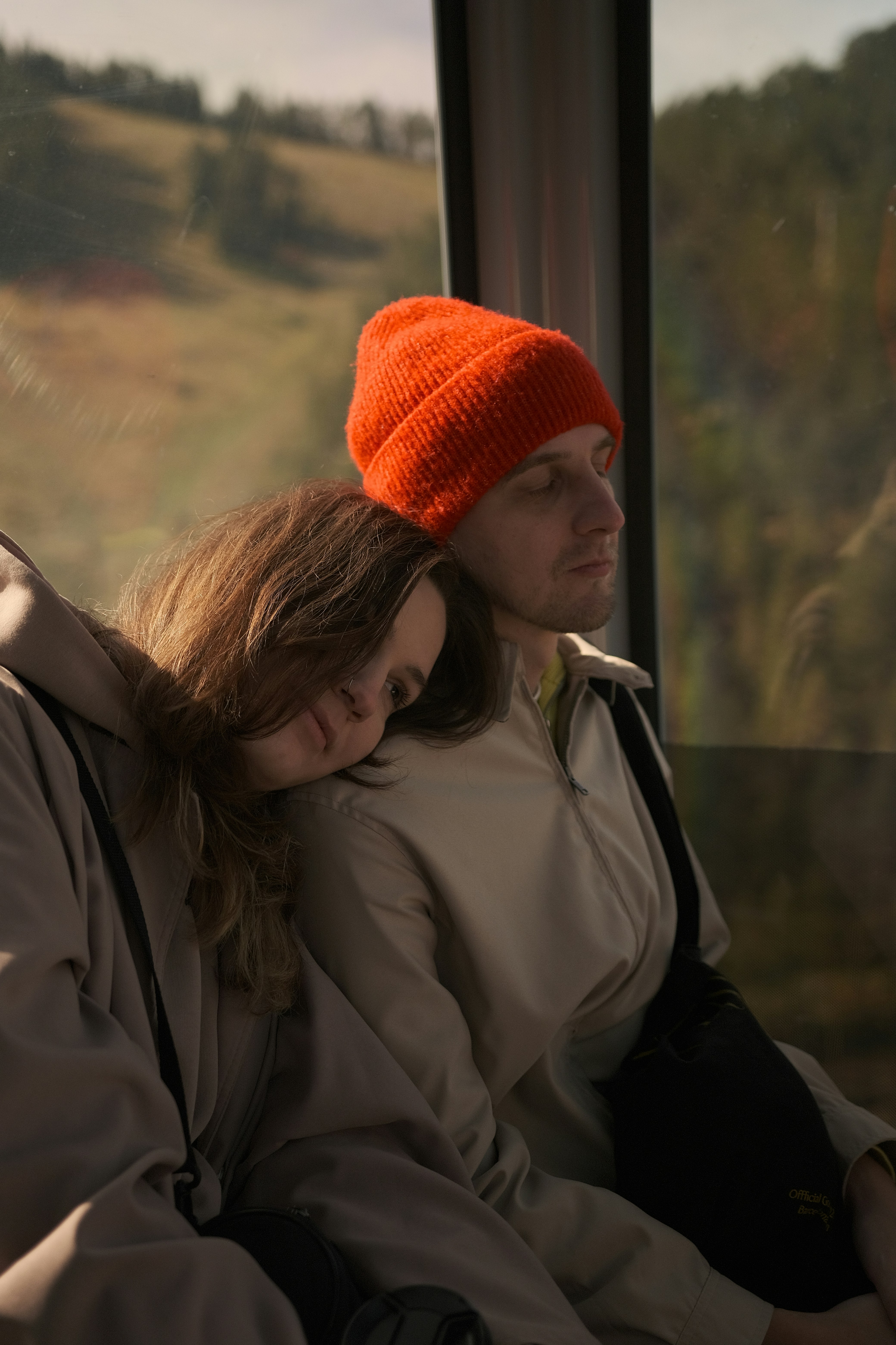 Two Travelers Rest on a Sunset Bus Ride