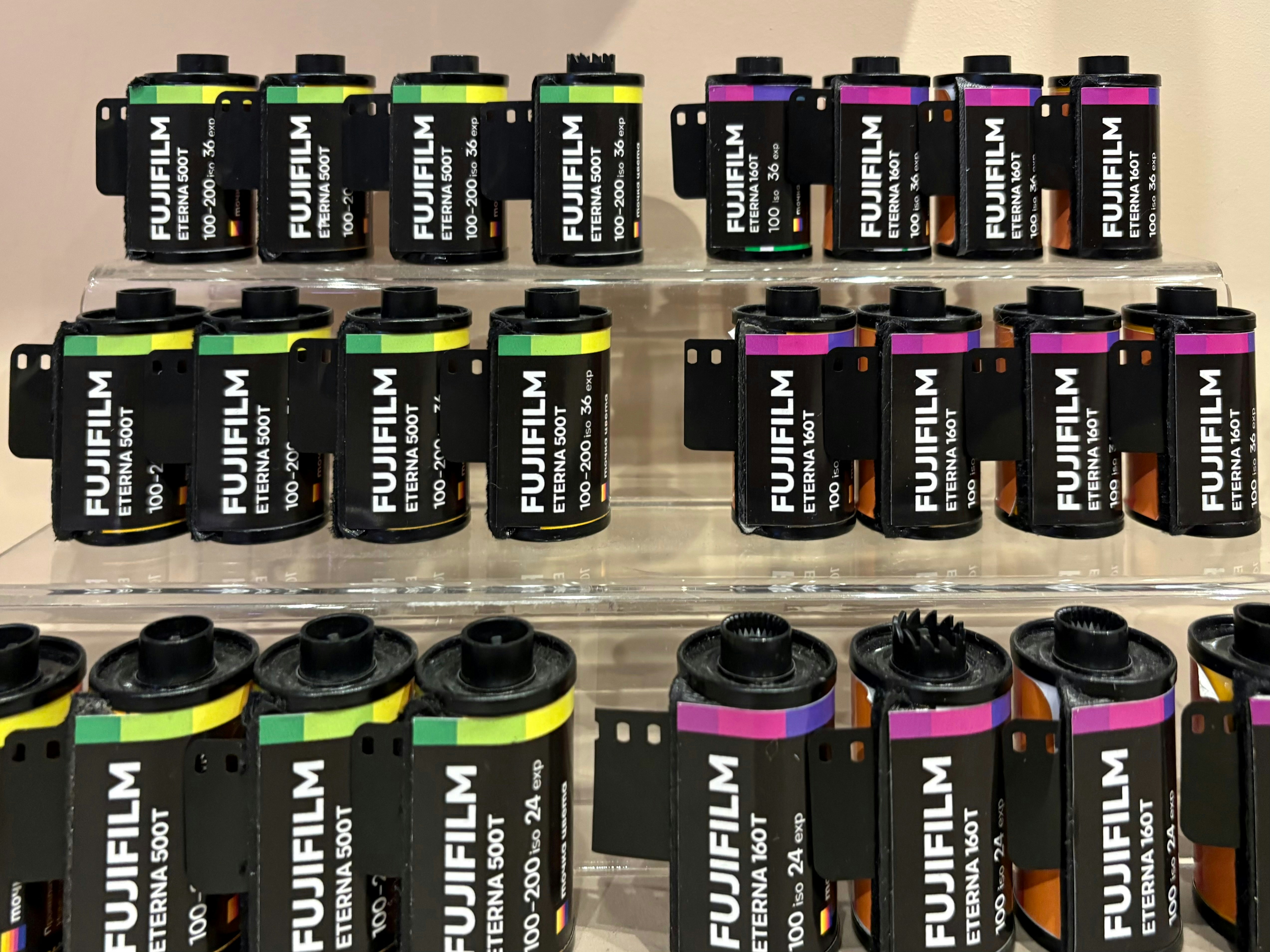 A collection of fujifilm film rolls is on display. photo – Free Bottle ...