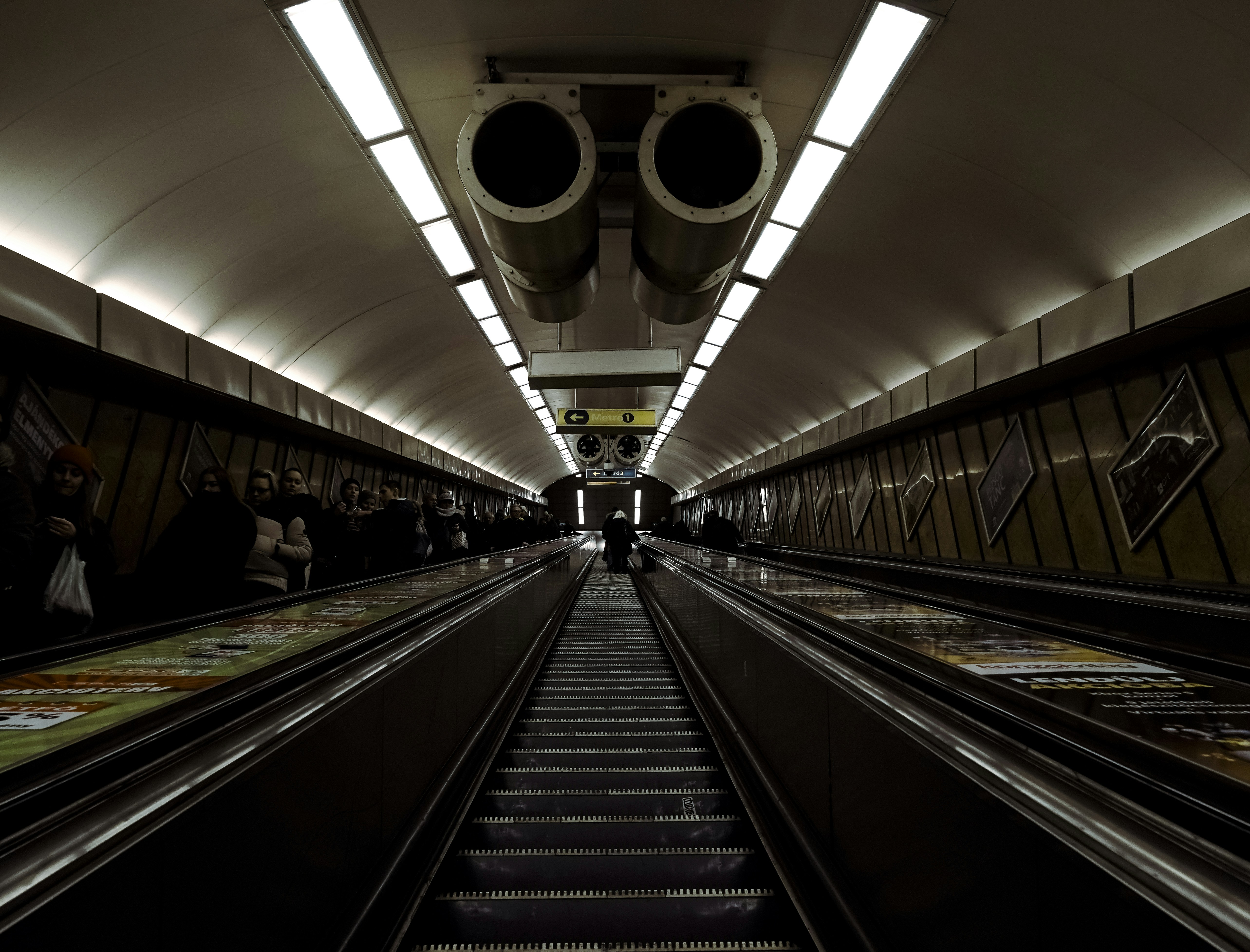 Escalera mecánica vacía en un túnel de metro largo y oscuro. foto ...