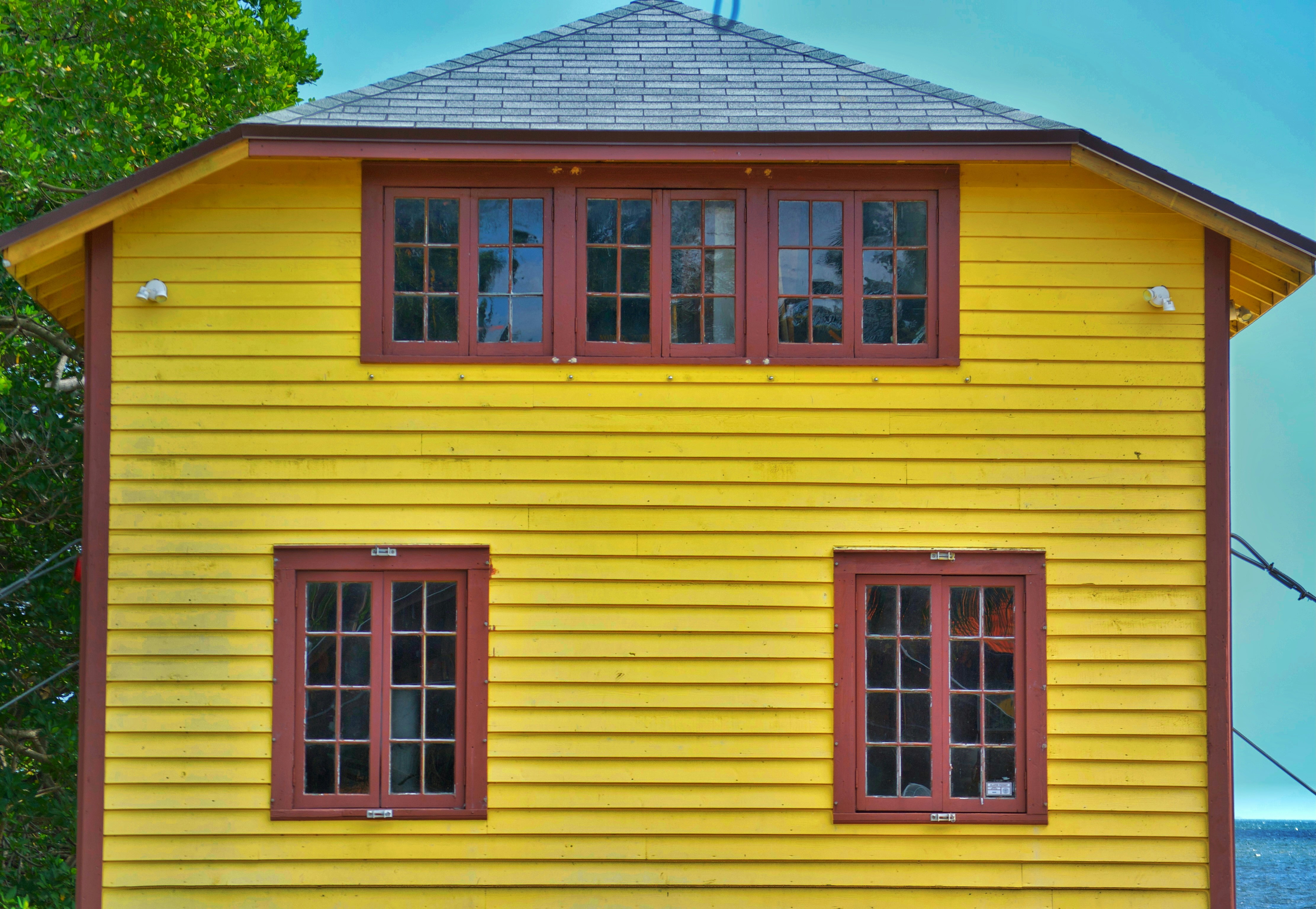 A bright yellow building with multiple windows. photo – Free Human ...