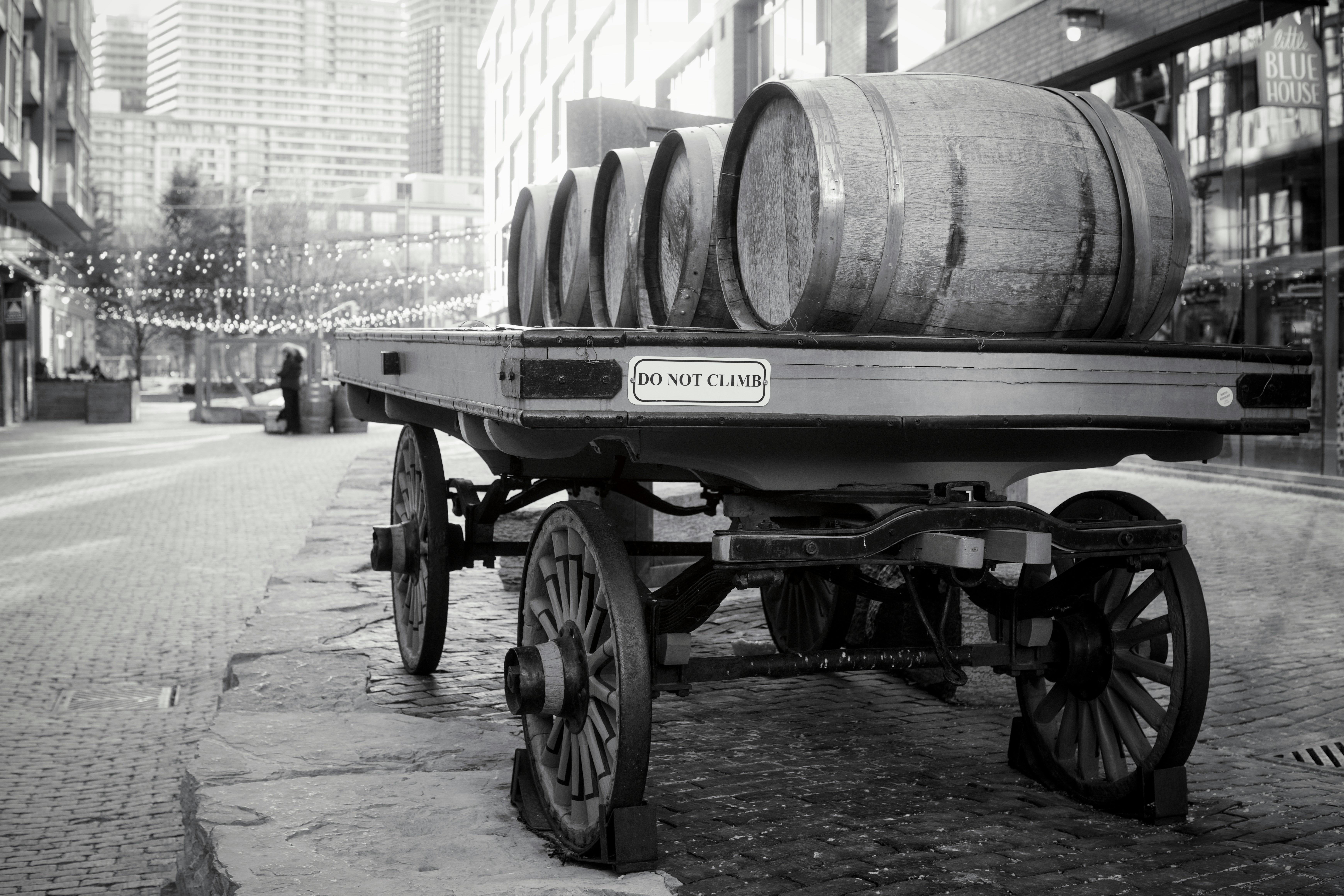 A wagon carries barrels down a city street. photo – Free Car Image on ...