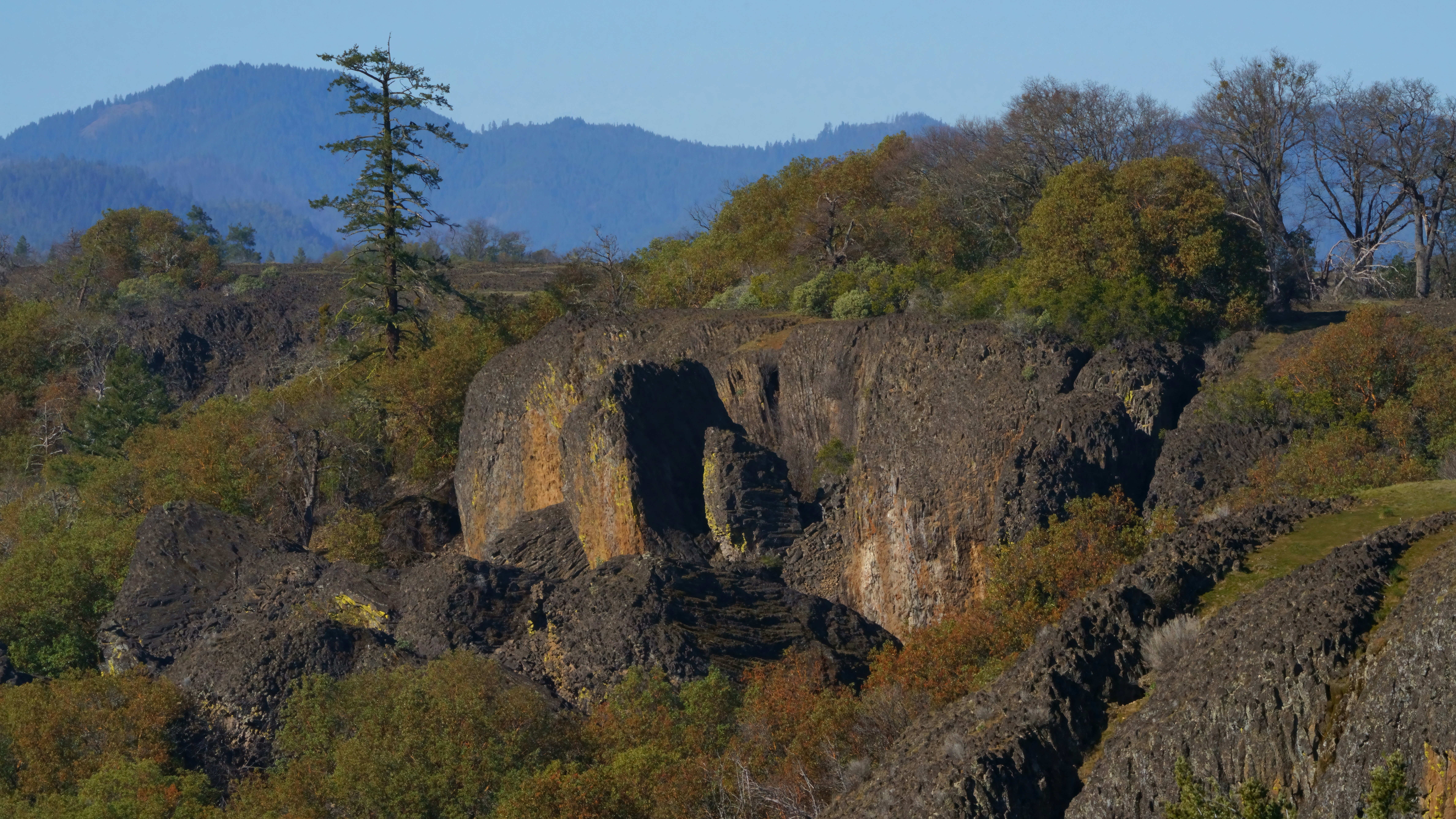 Rugged Stone Archway Amid Autumn Cliffs
