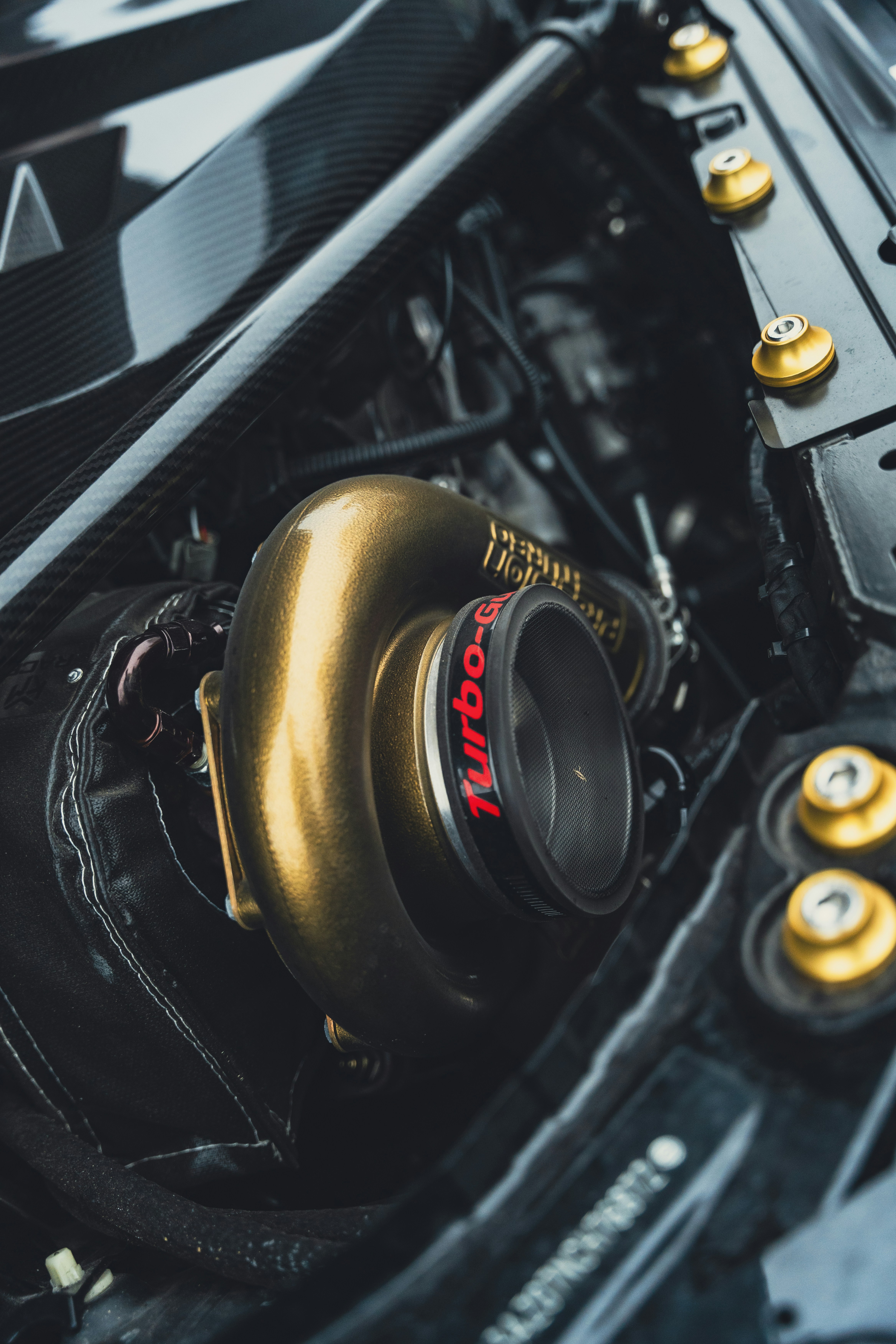 Gold-colored turbocharger installed in a car engine. photo – Free Usa ...