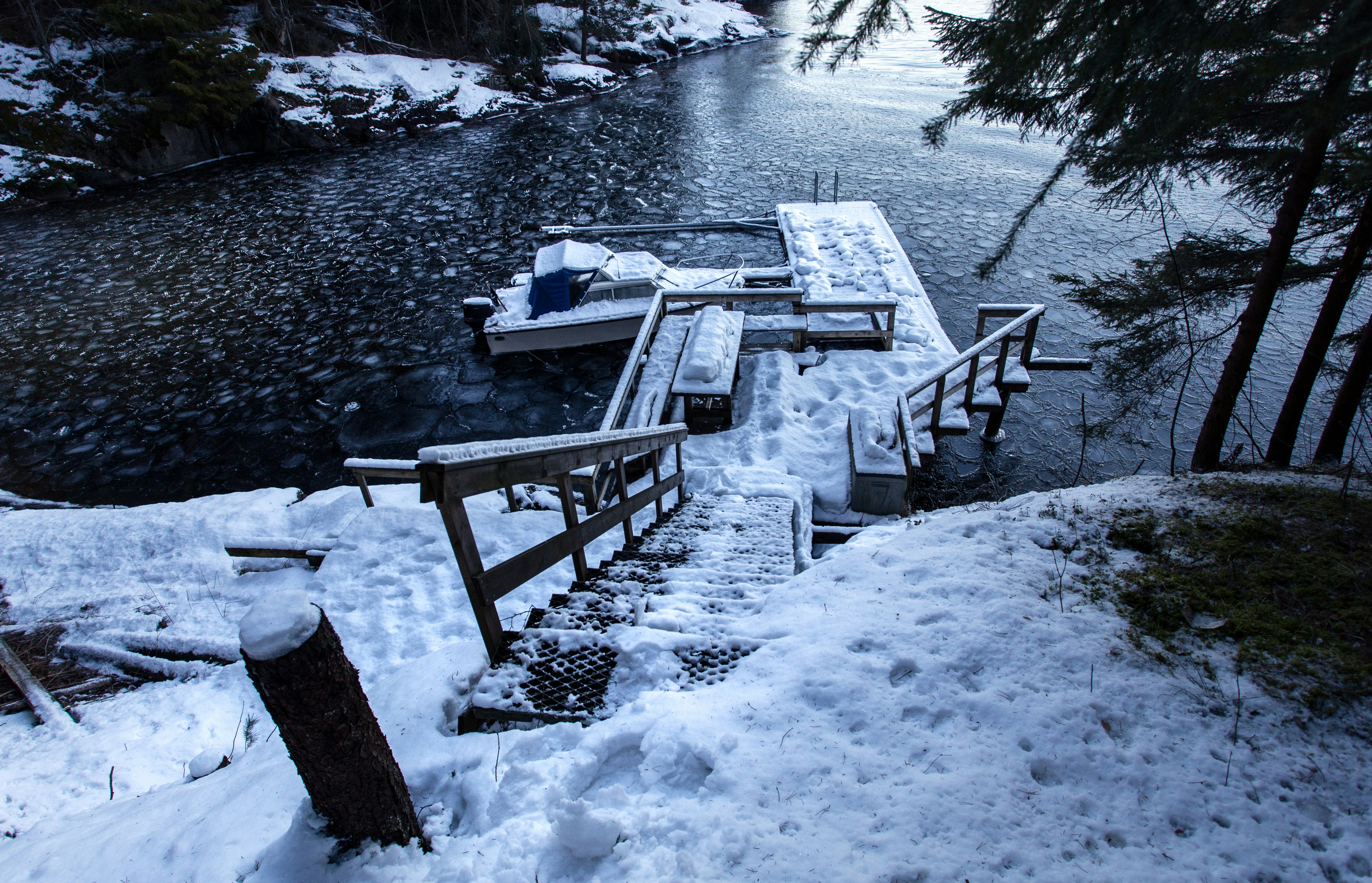 A snowy dock extends into a frozen lake. photo – Free Snow Image on ...