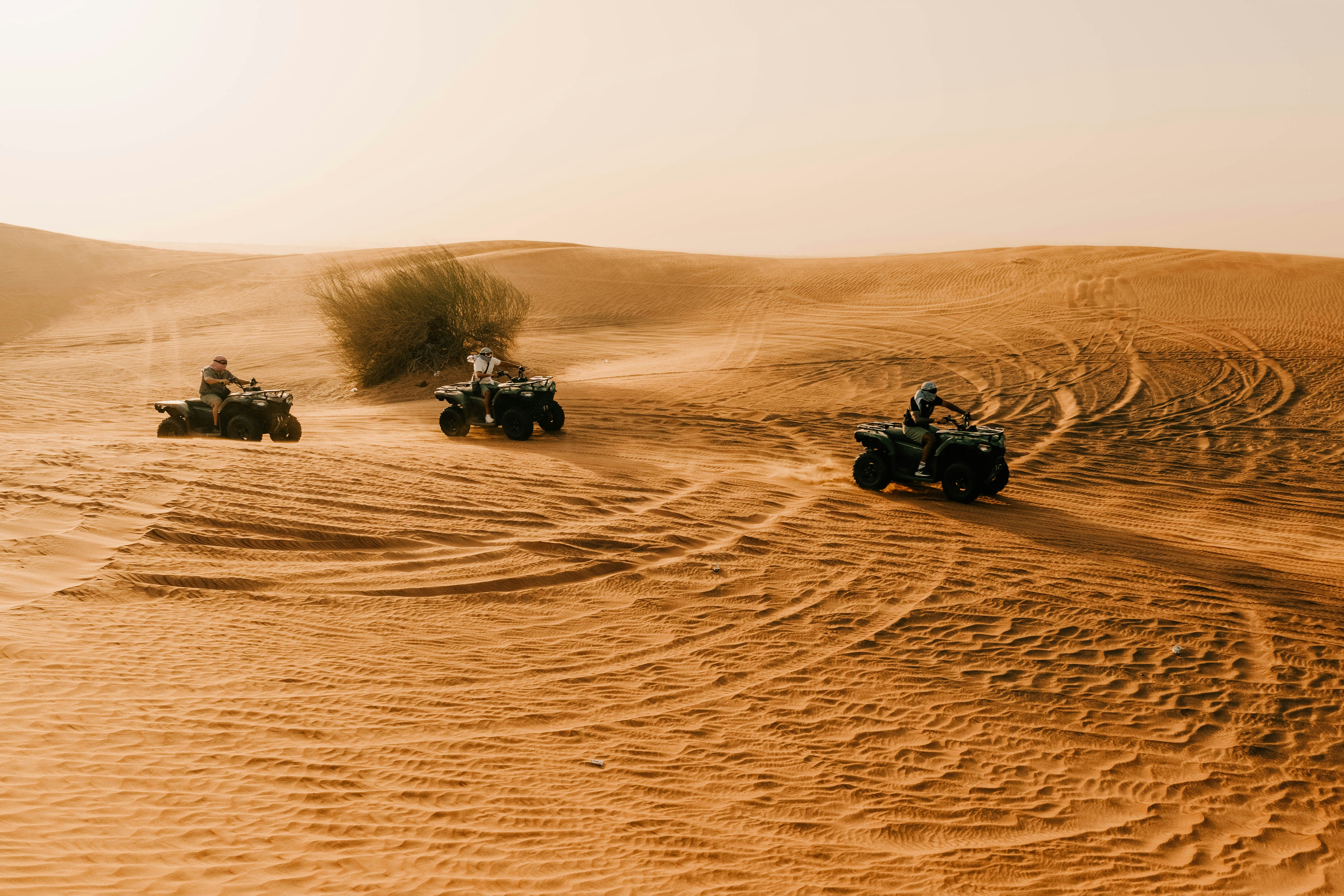 Atvs are riding across the sandy desert. photo – Free Human Image on ...