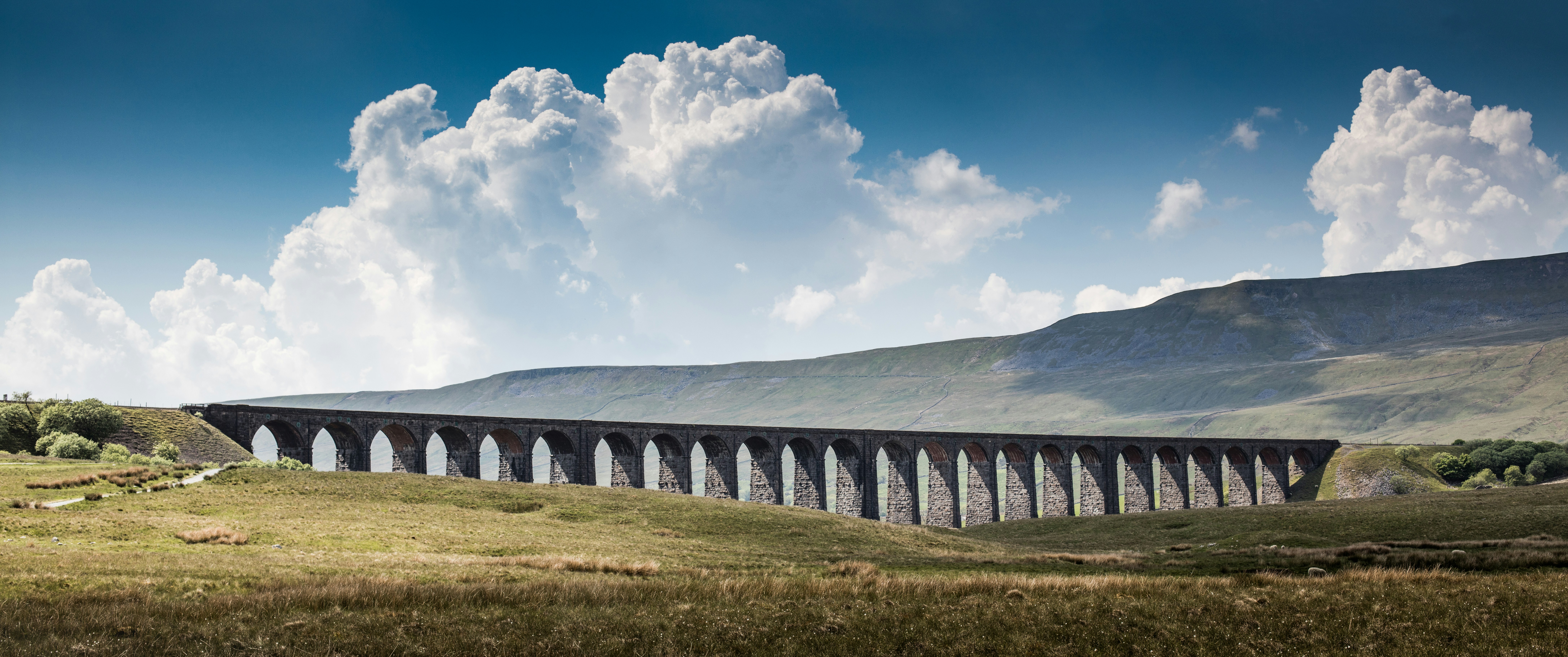 Row of Stone Arches Crossing a Windswept Moor