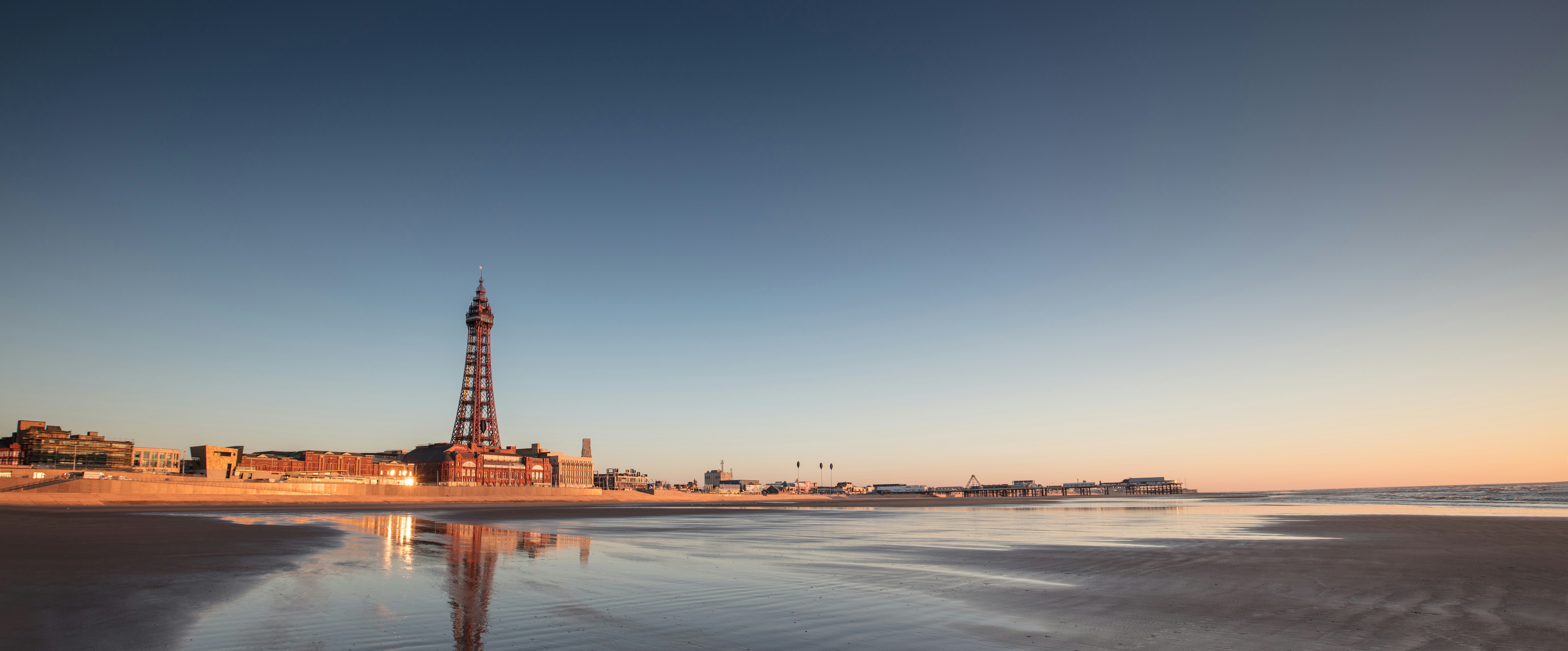 Lighthouse at Sunset: Reflections on a Calm Seaside