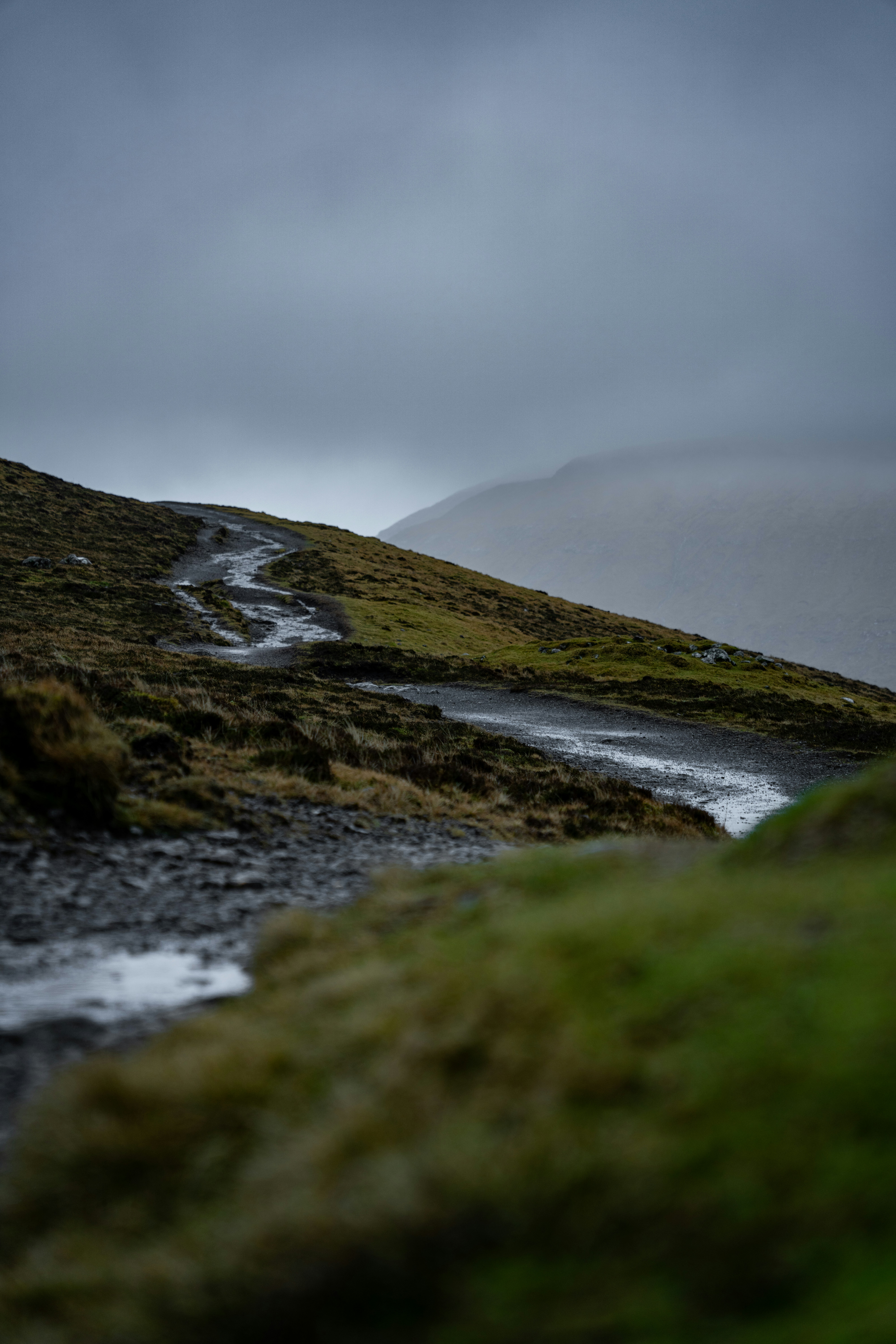 Winding Moor Path Beneath Fog-Wrapped Hills