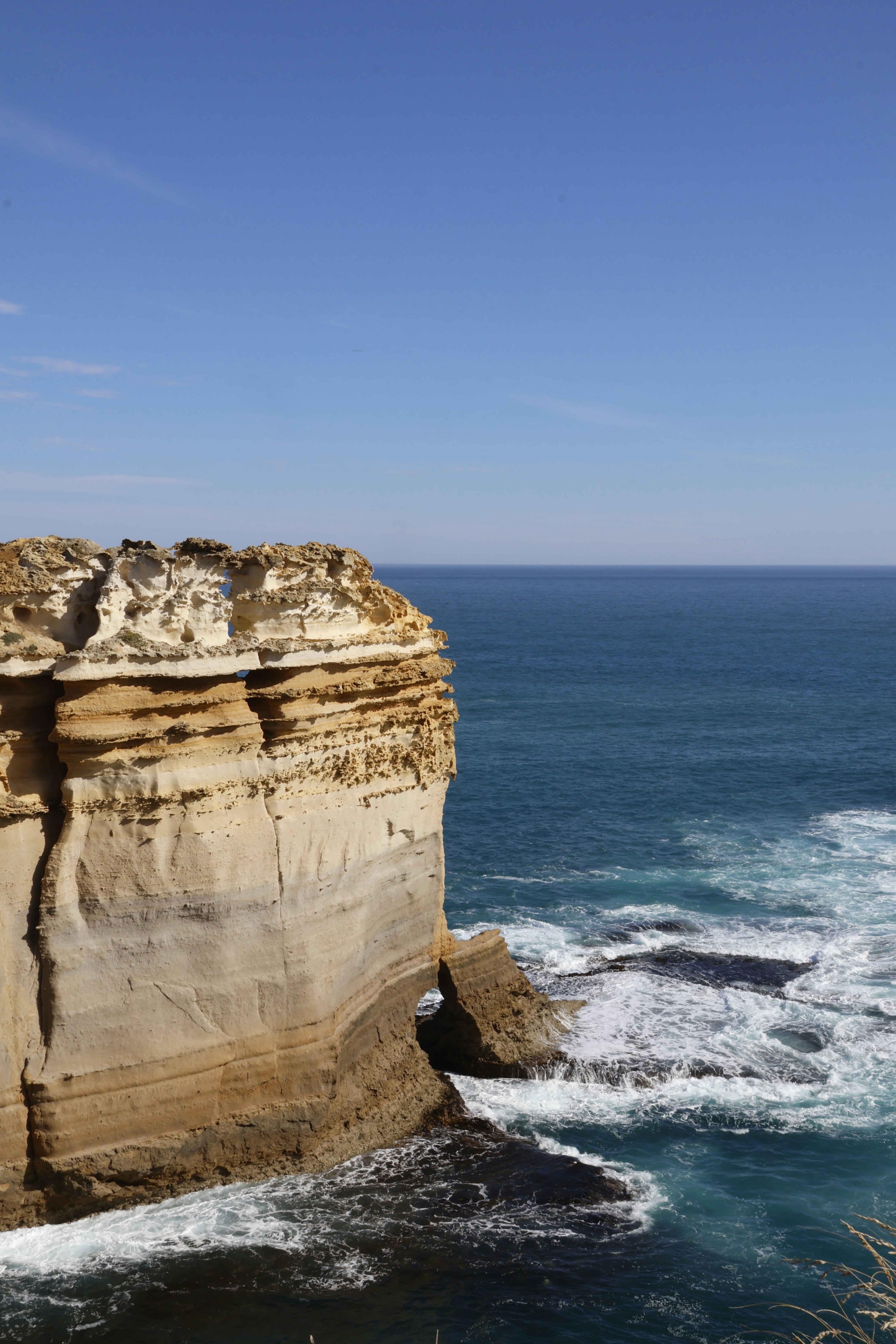 Cliffs meet the ocean under a blue sky. photo – Free Beach Image on ...
