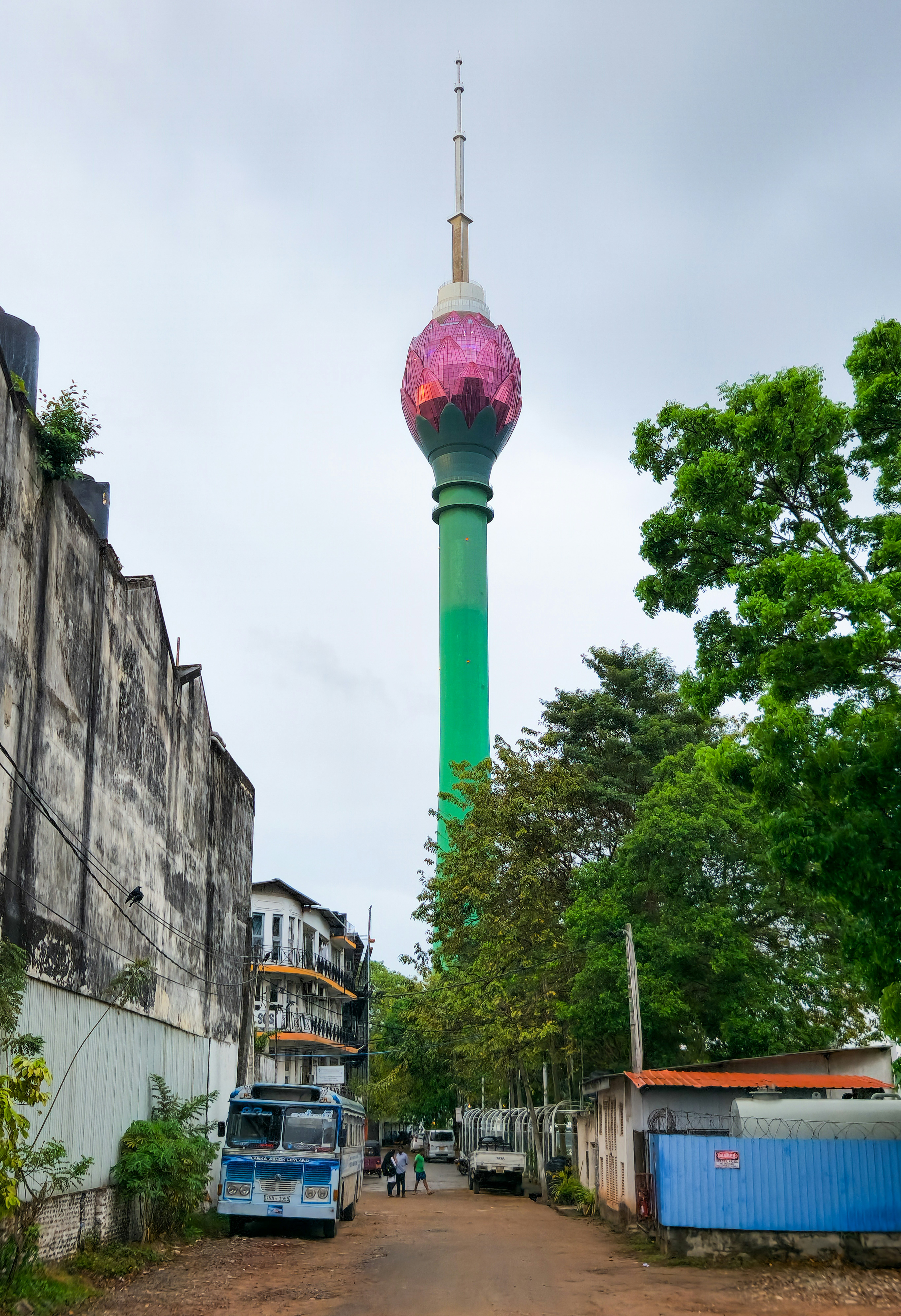 Verdant Spire Rising: A Pink-Crowned Tower Dominates a Quiet Street