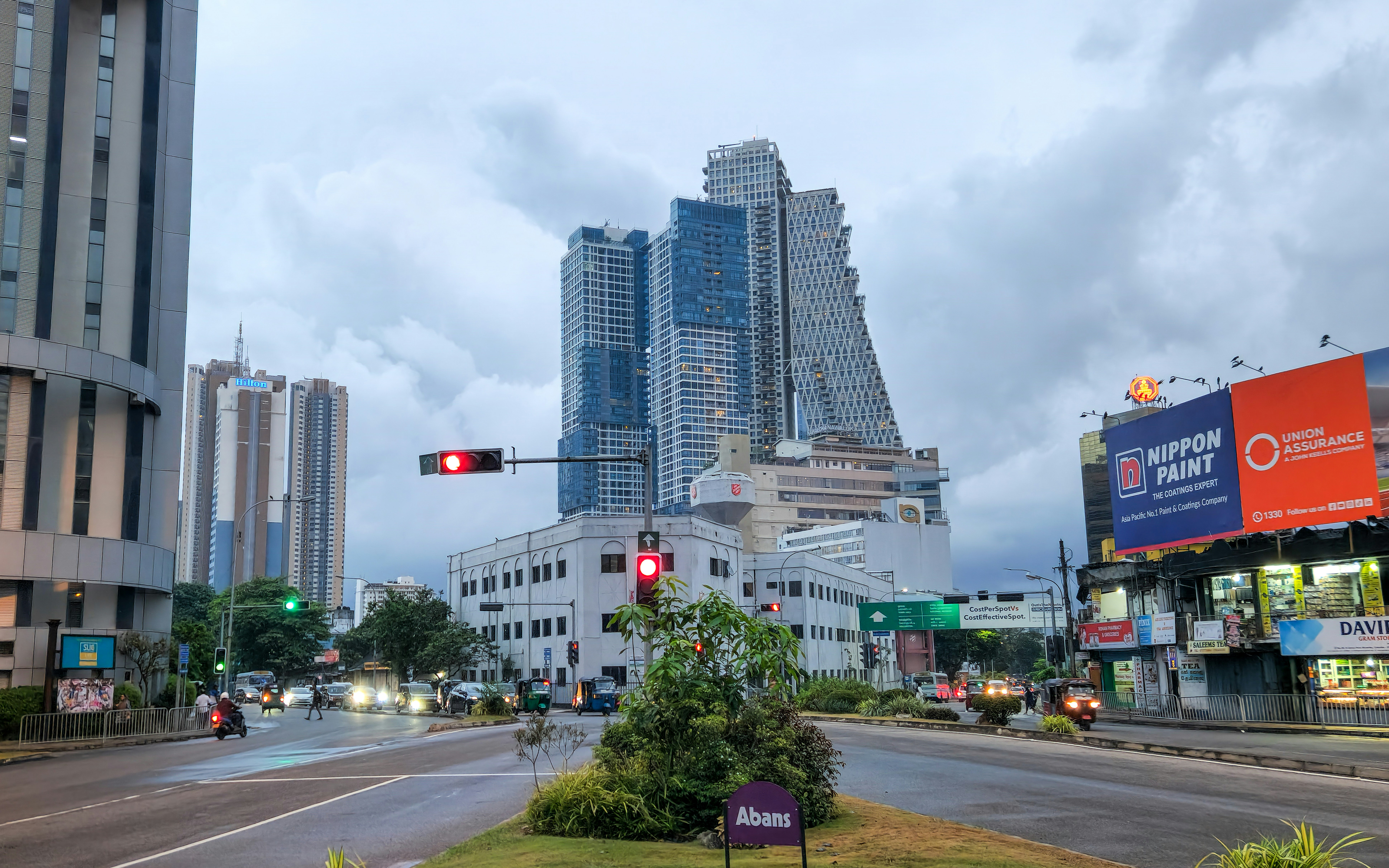 Colombo cityscape with modern high-rise buildings under a cloudy sky.
