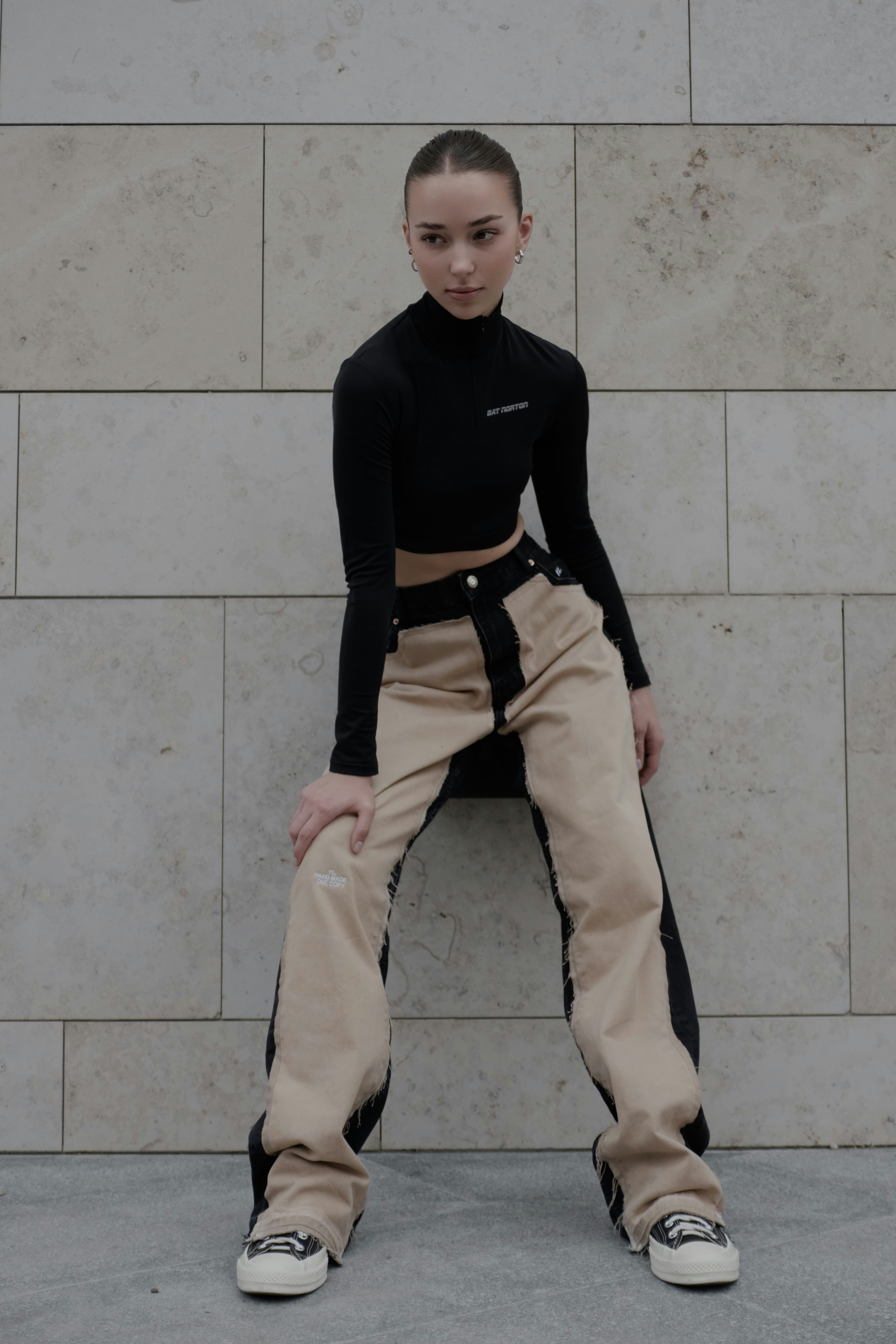 Beige-panel Streetwear Portrait Against Pale Tile Backdrop