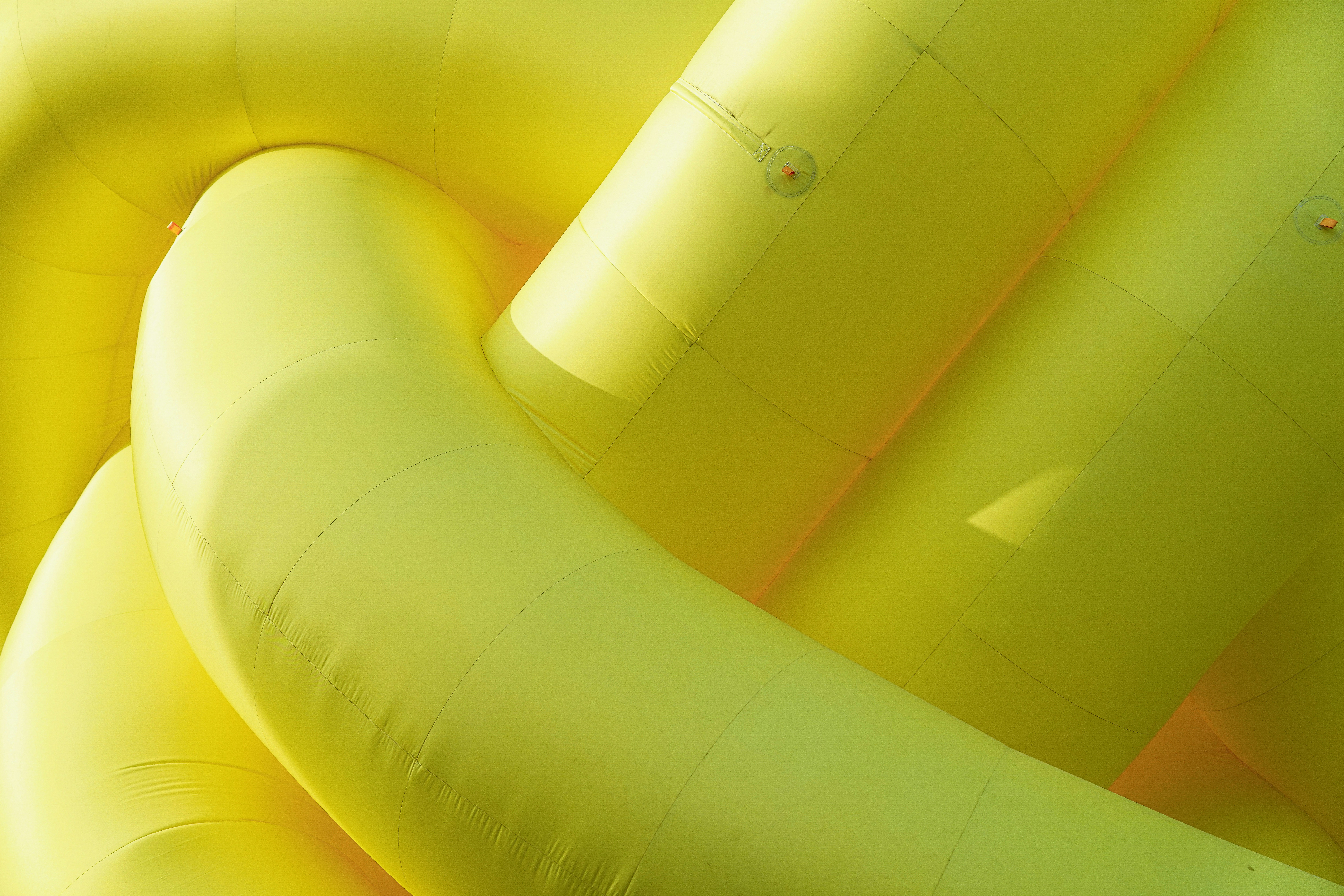 Yellow inflatable tubes intertwined in a close-up shot. photo – Free ...