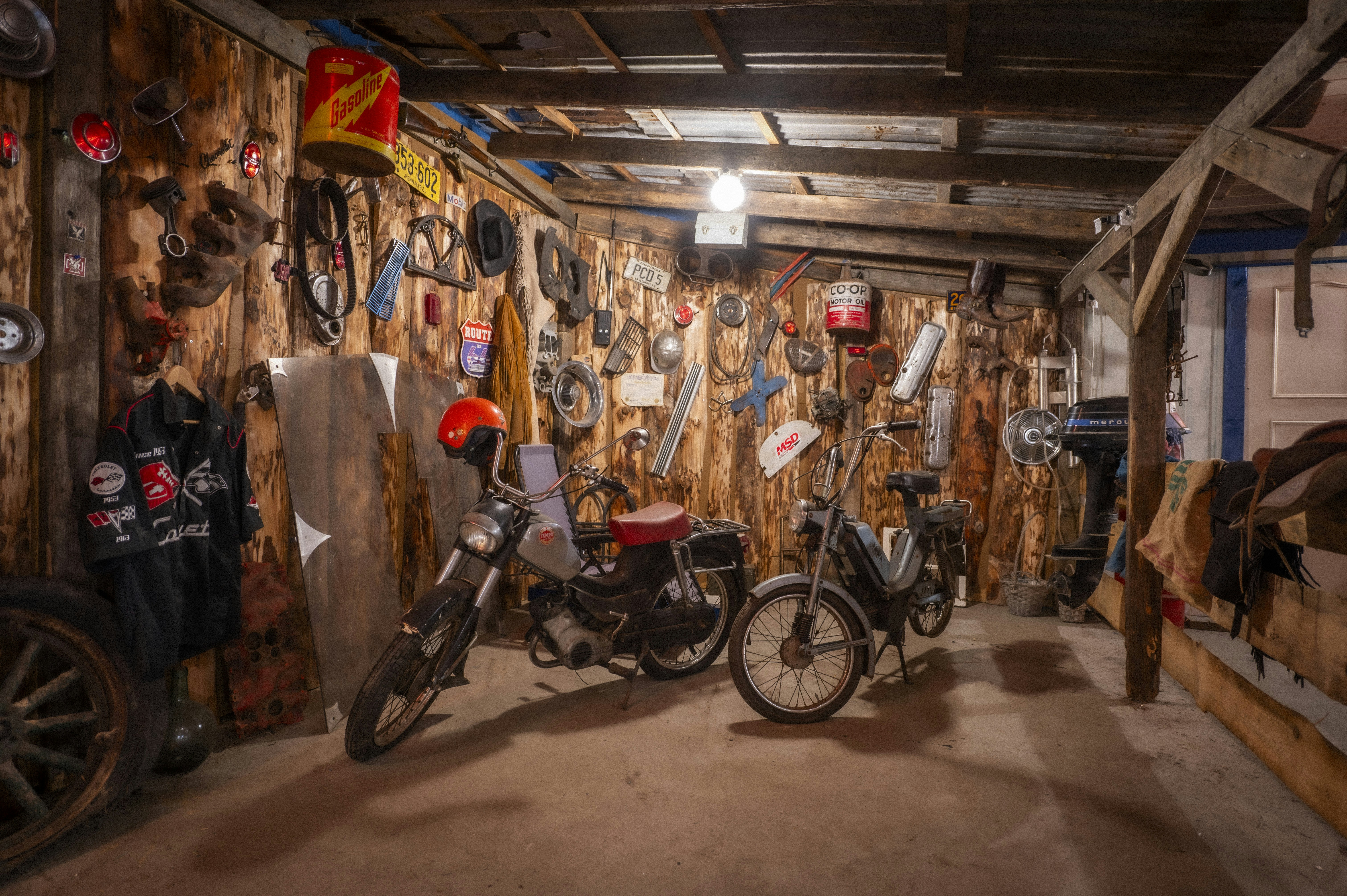 Vintage motorcycles parked inside a rustic wooden shed. photo – Free ...