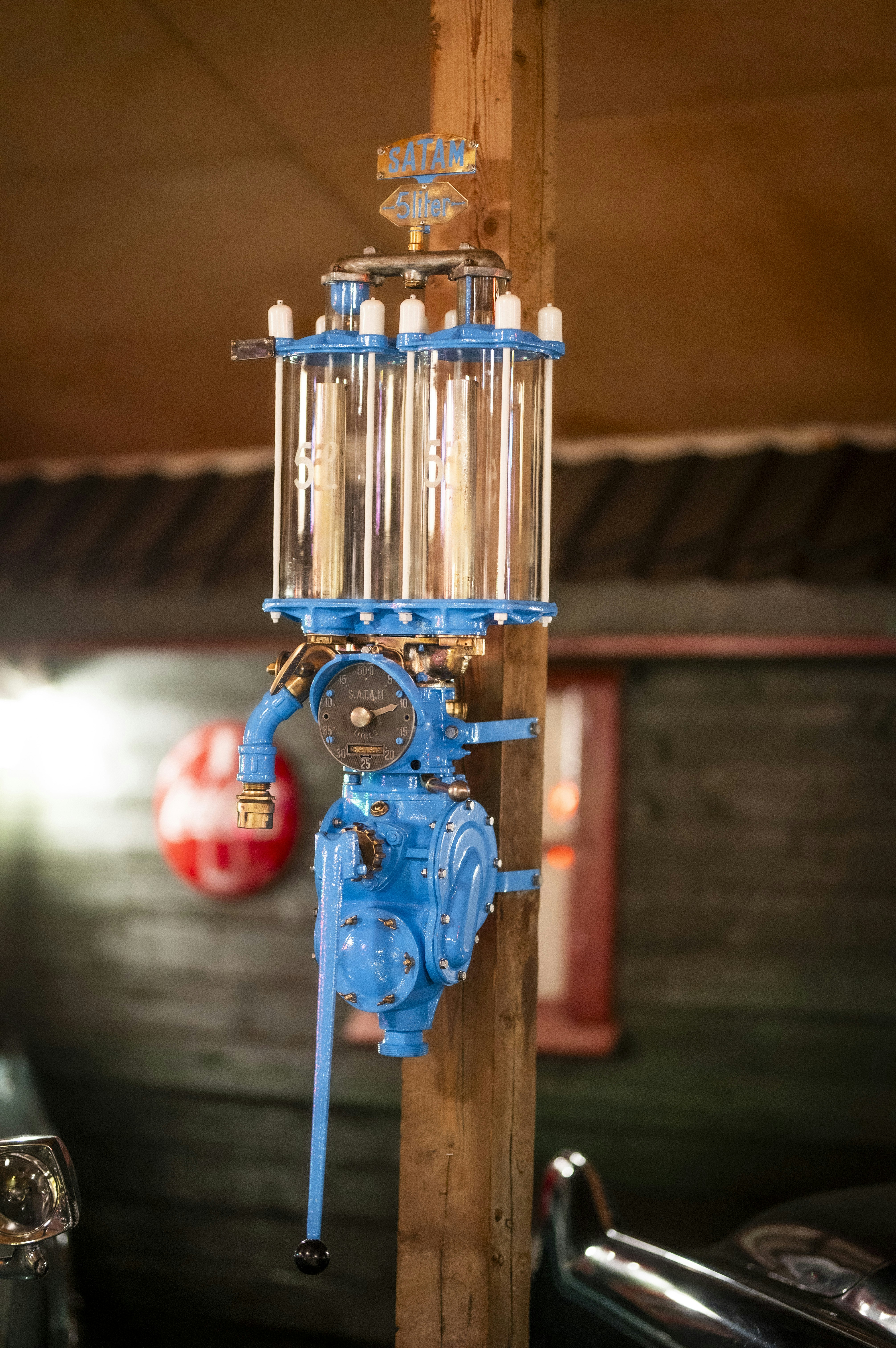 Blue Valve Assembly on a Wooden Post in a Dim Interior