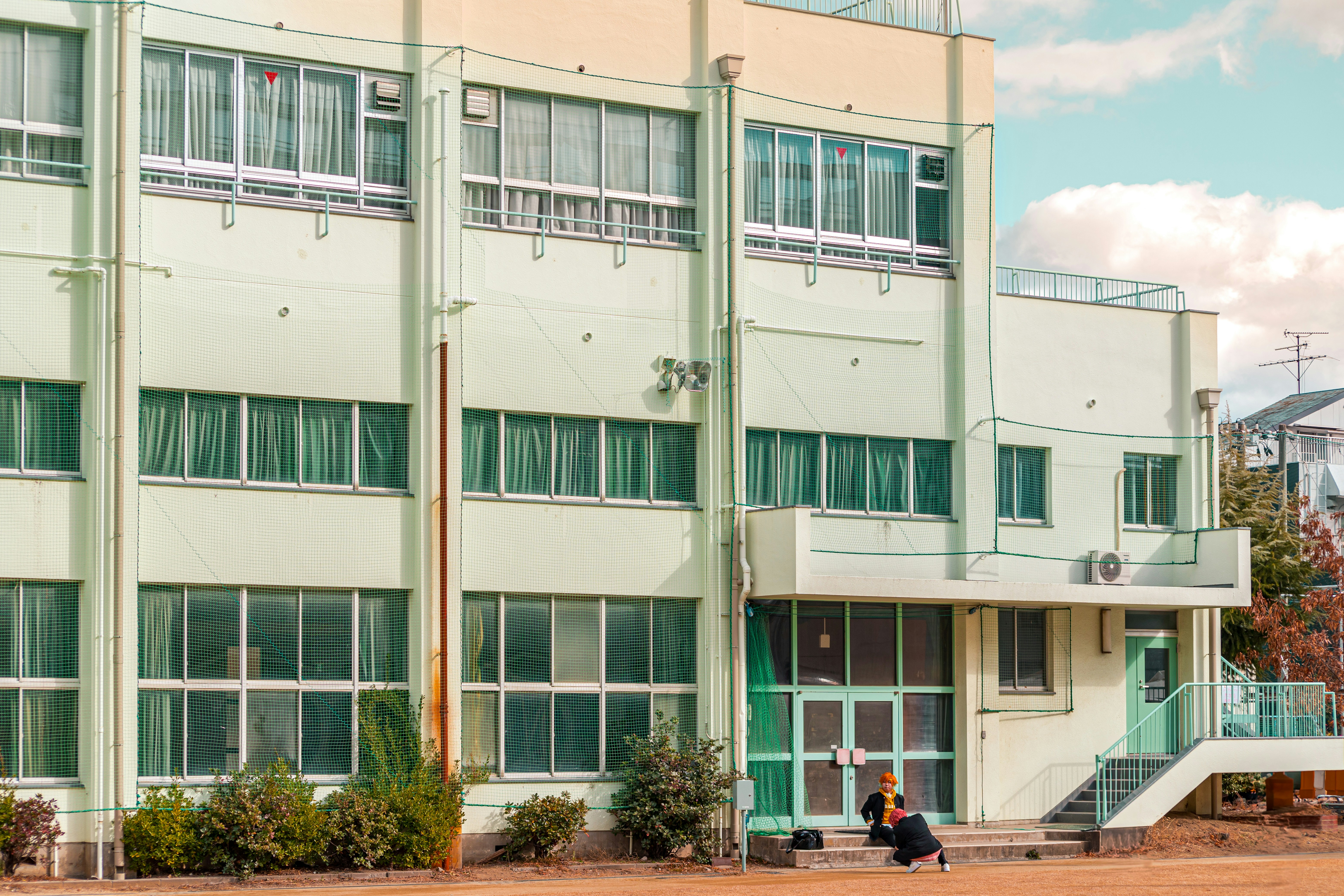 Un edificio escolar verde se muestra bajo un cielo azul. foto – Imagen de Edificio gratuita en ...