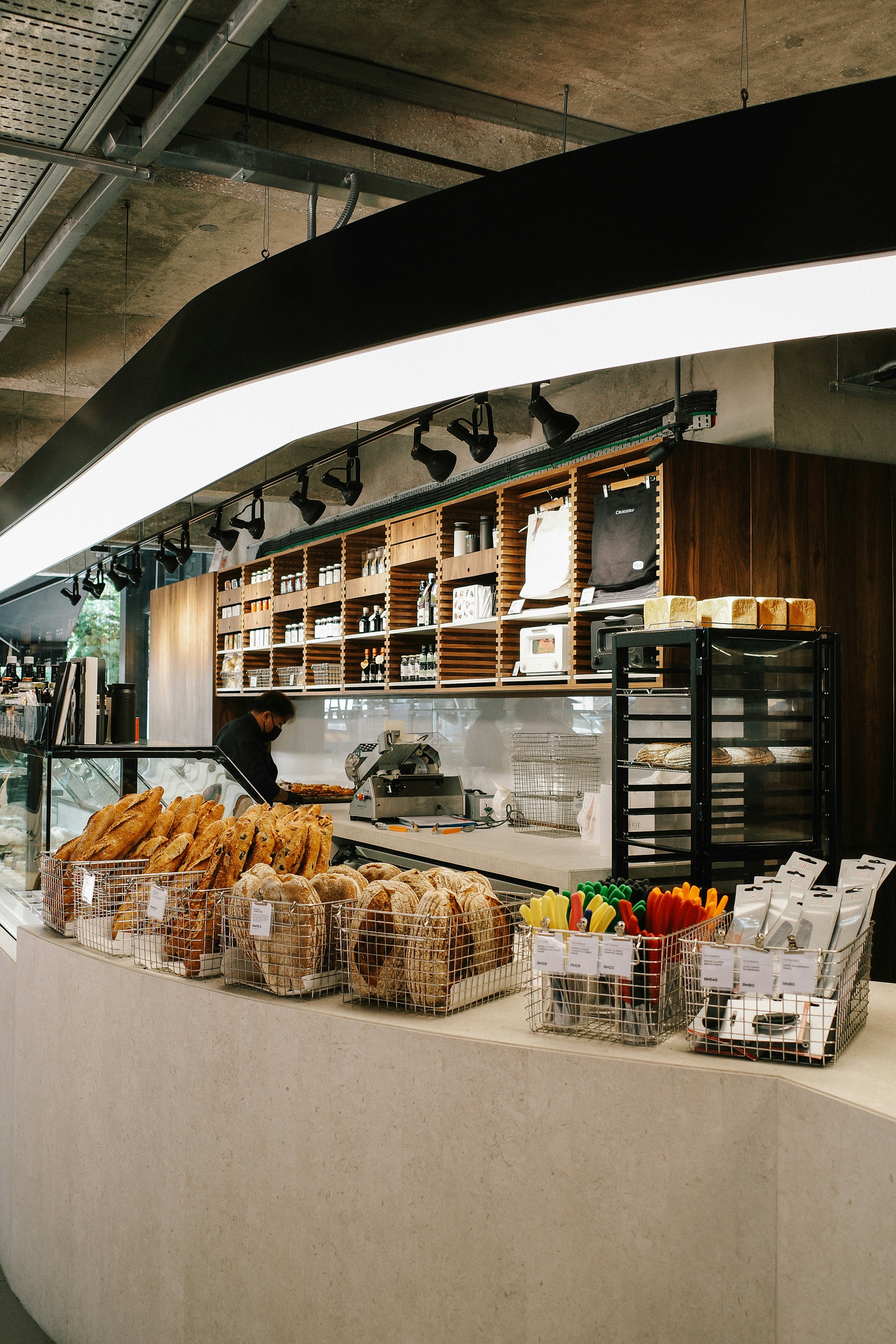 A bakery counter displays pastries and a kitchen area. photo – Free ...