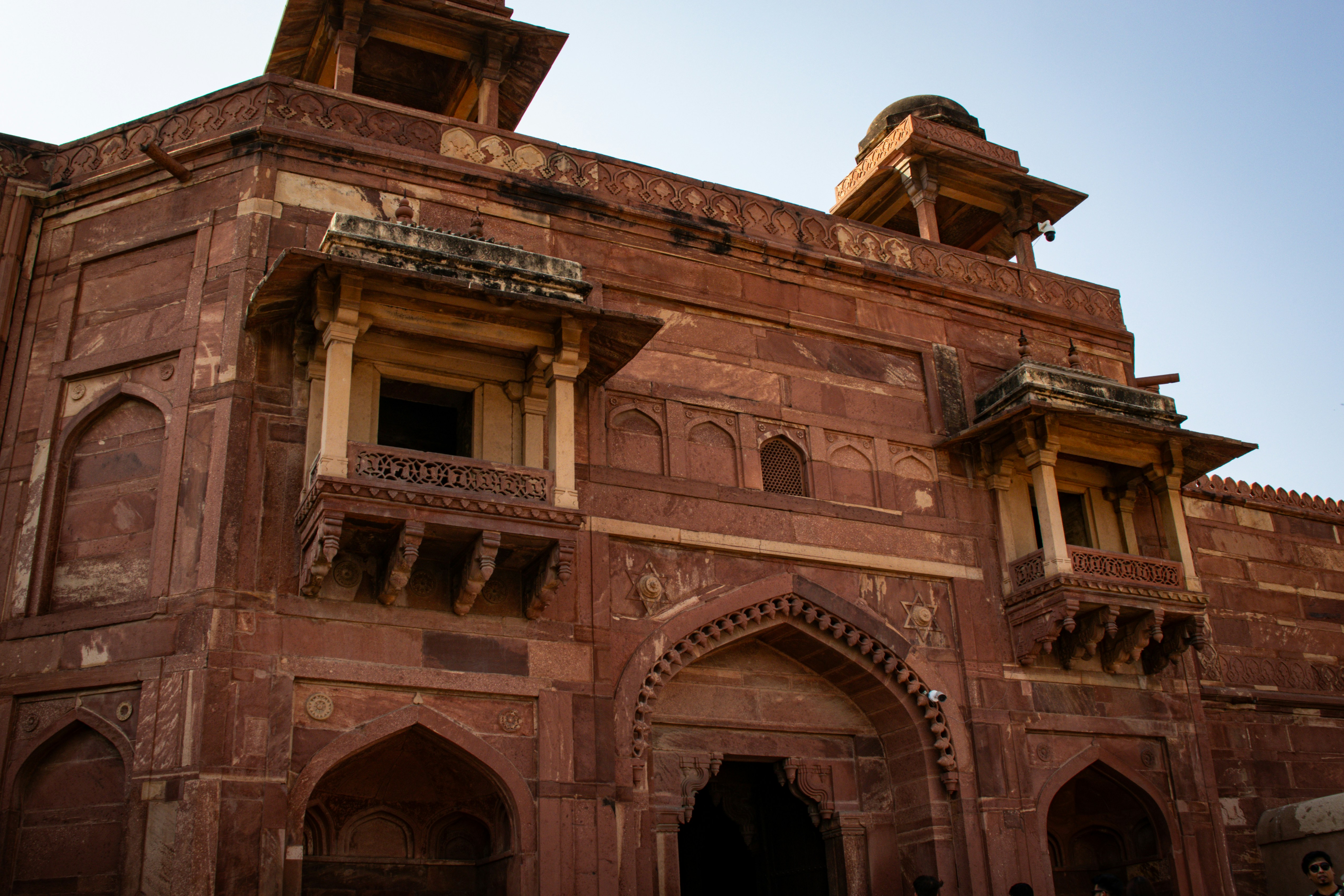 A red fort building with detailed, traditional architecture. photo ...