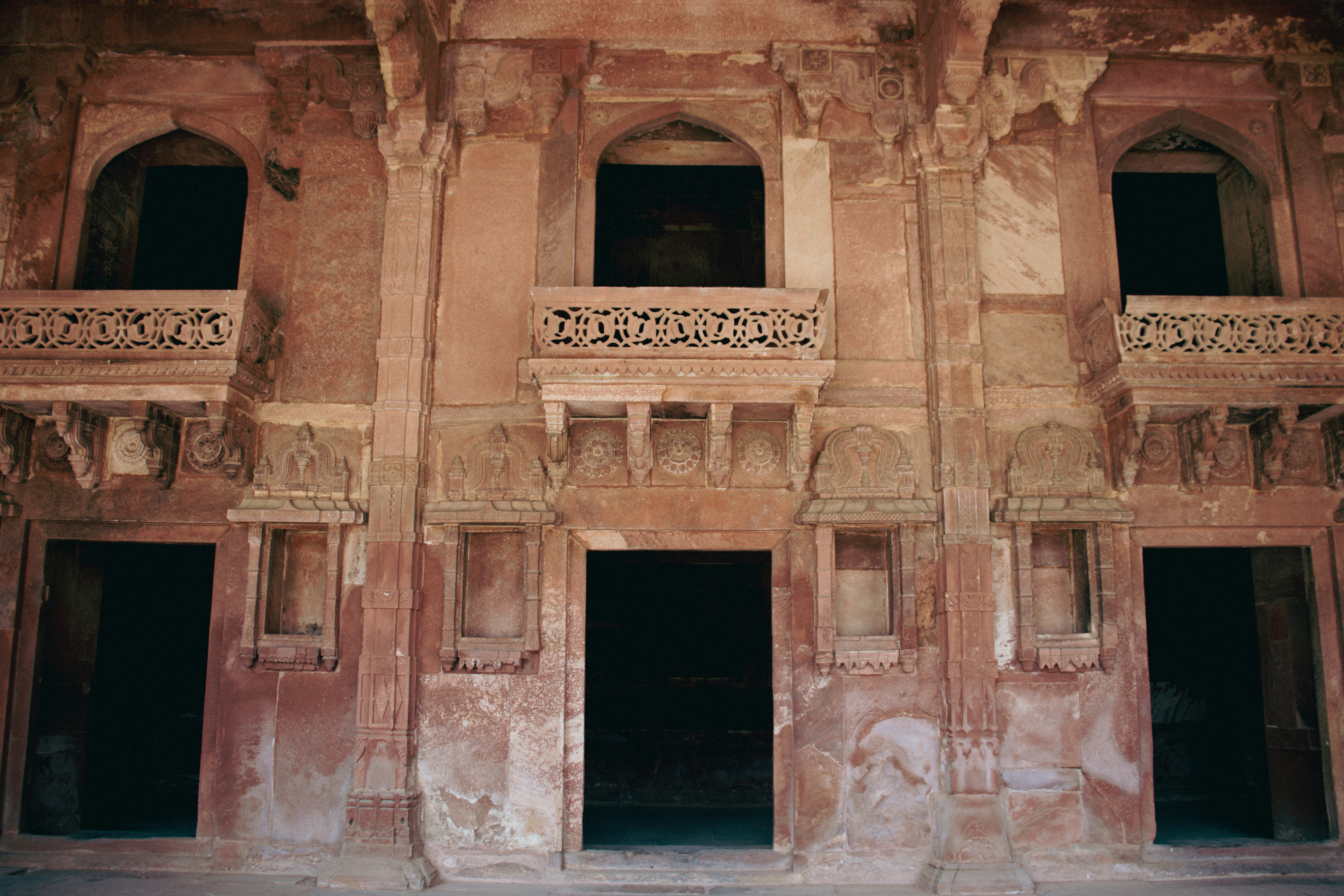 Old, decorated building with windows and doors.