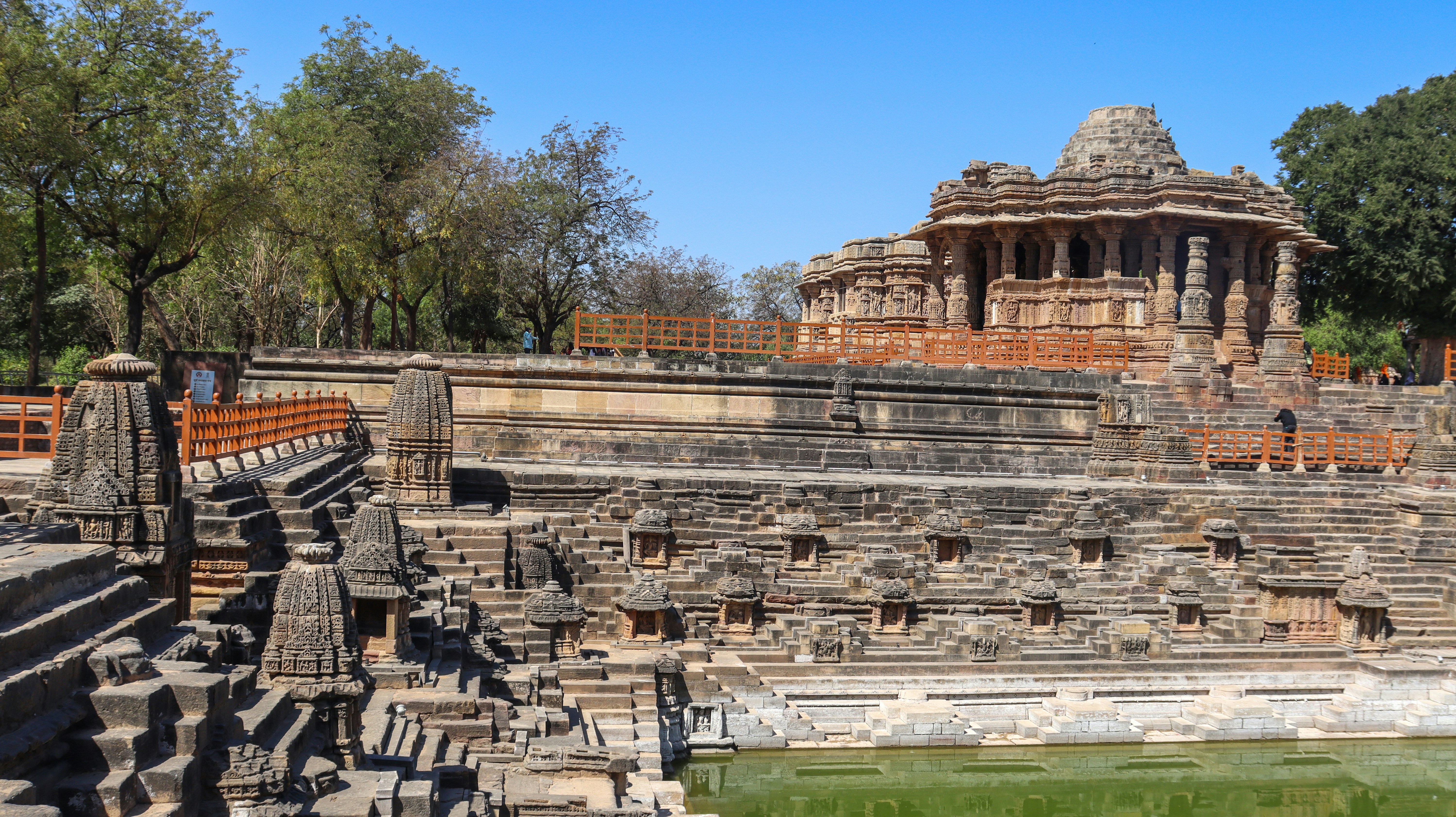 Sunlit Steps and Temple Teal: Ruins of an Ancient Rock-Cut Amphitheater