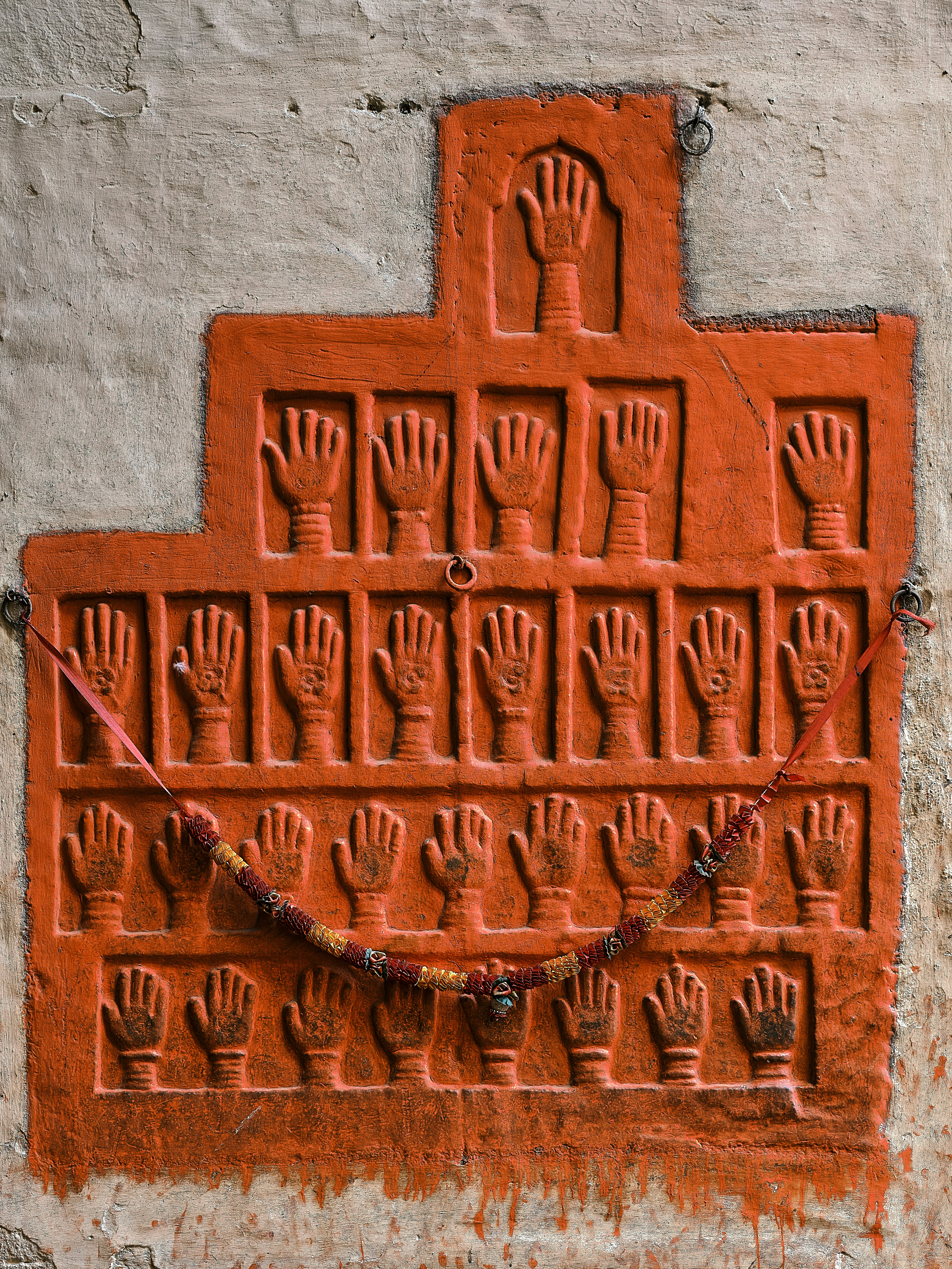 Terracotta Hand Mosaic: A Garlanded Wall of Repetition